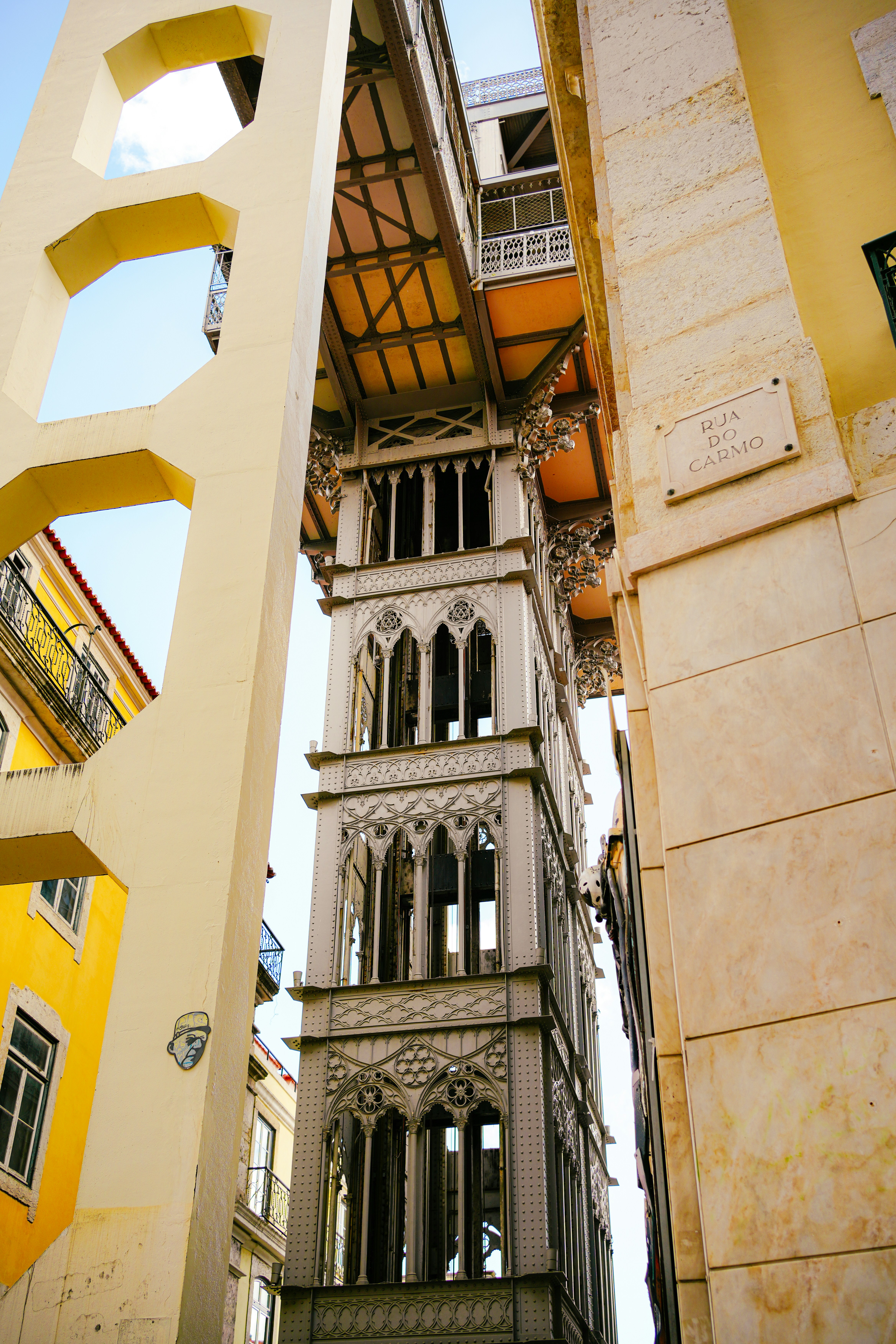 Gothic Ironwork Tower Between Warm Facades