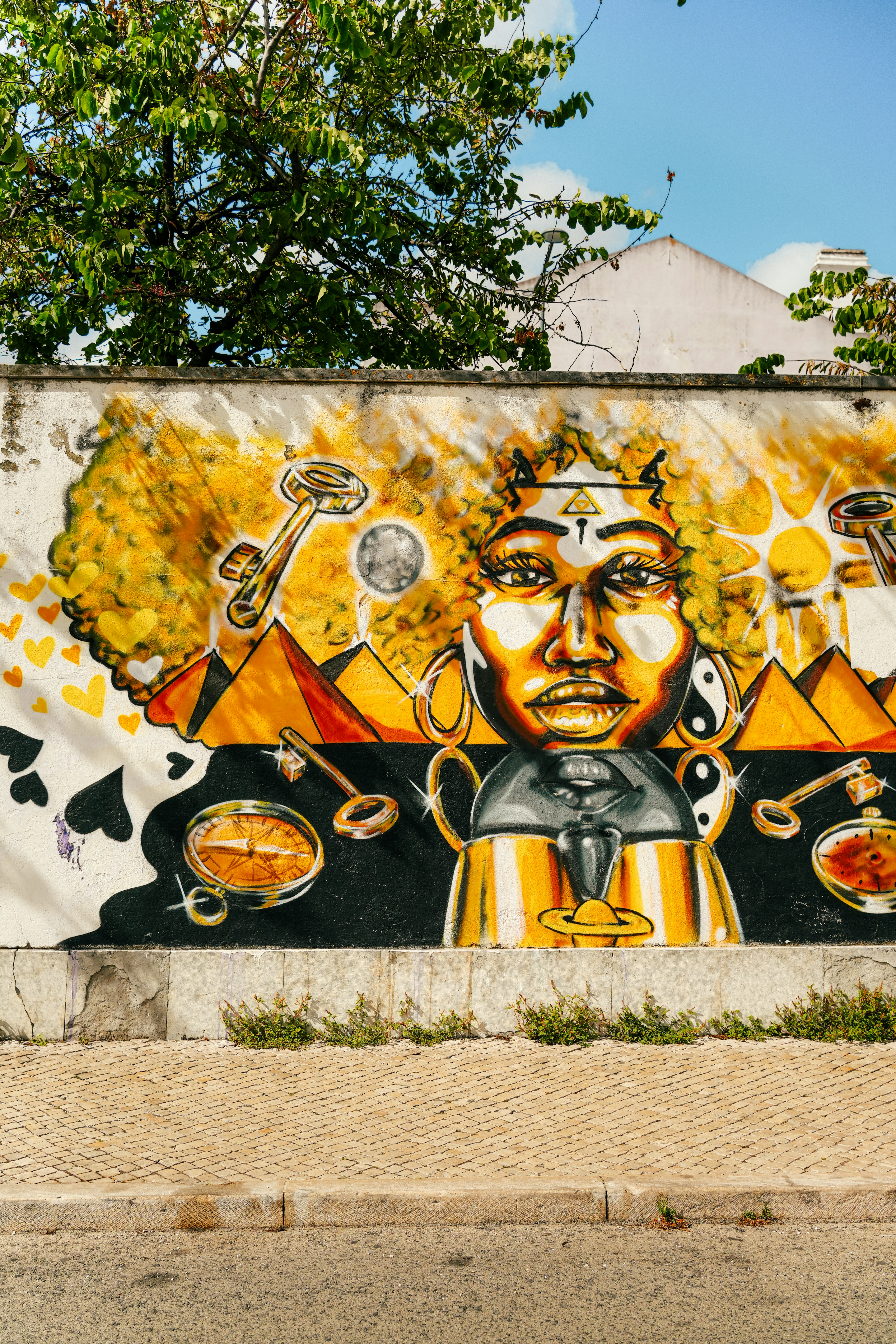 Vibrant Street-Mural Portrait Surrounded by Fiery Pyramids and Cosmic Orbs