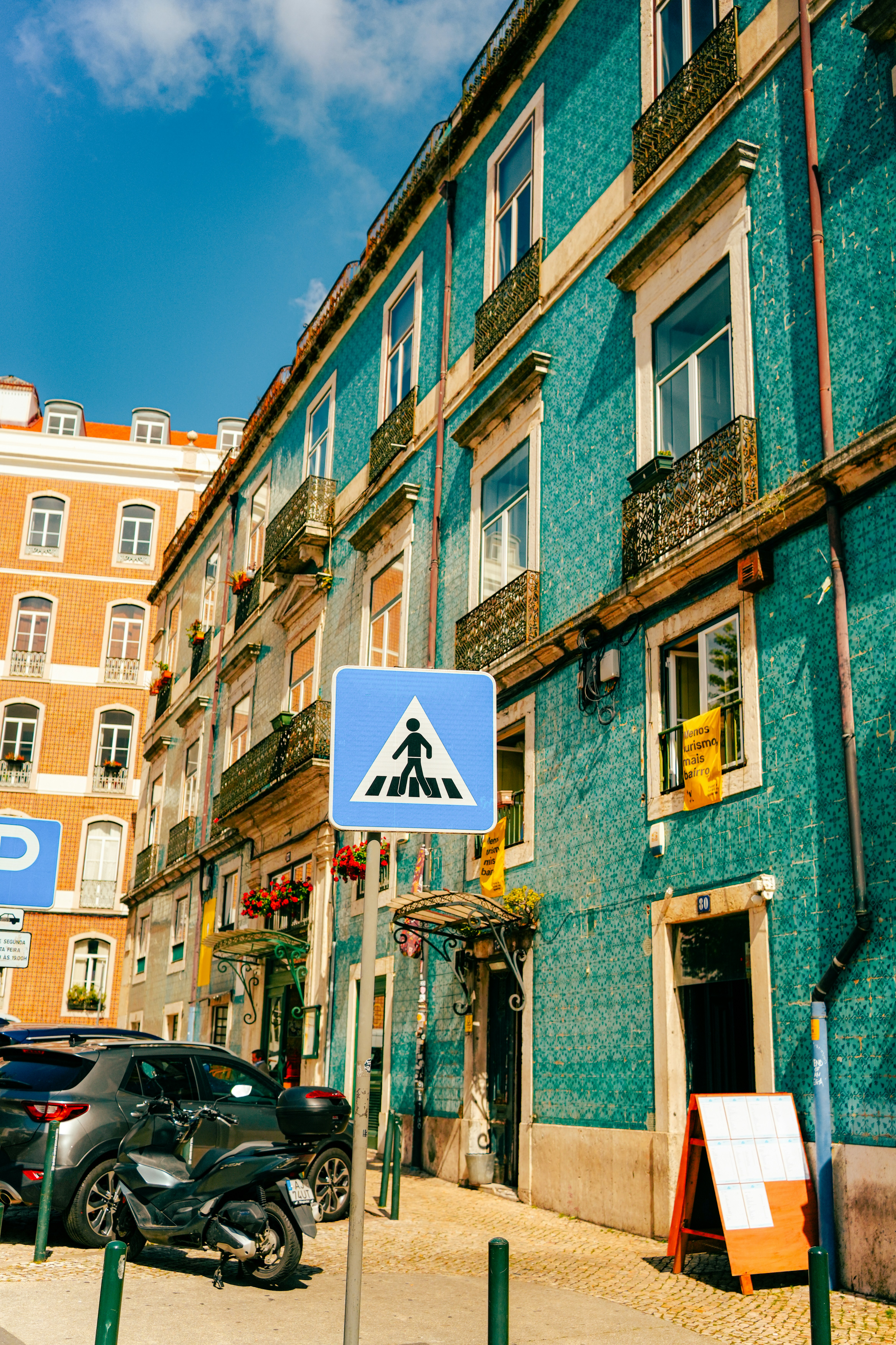 Teal Facade Street with Pedestrian Crossing Sign