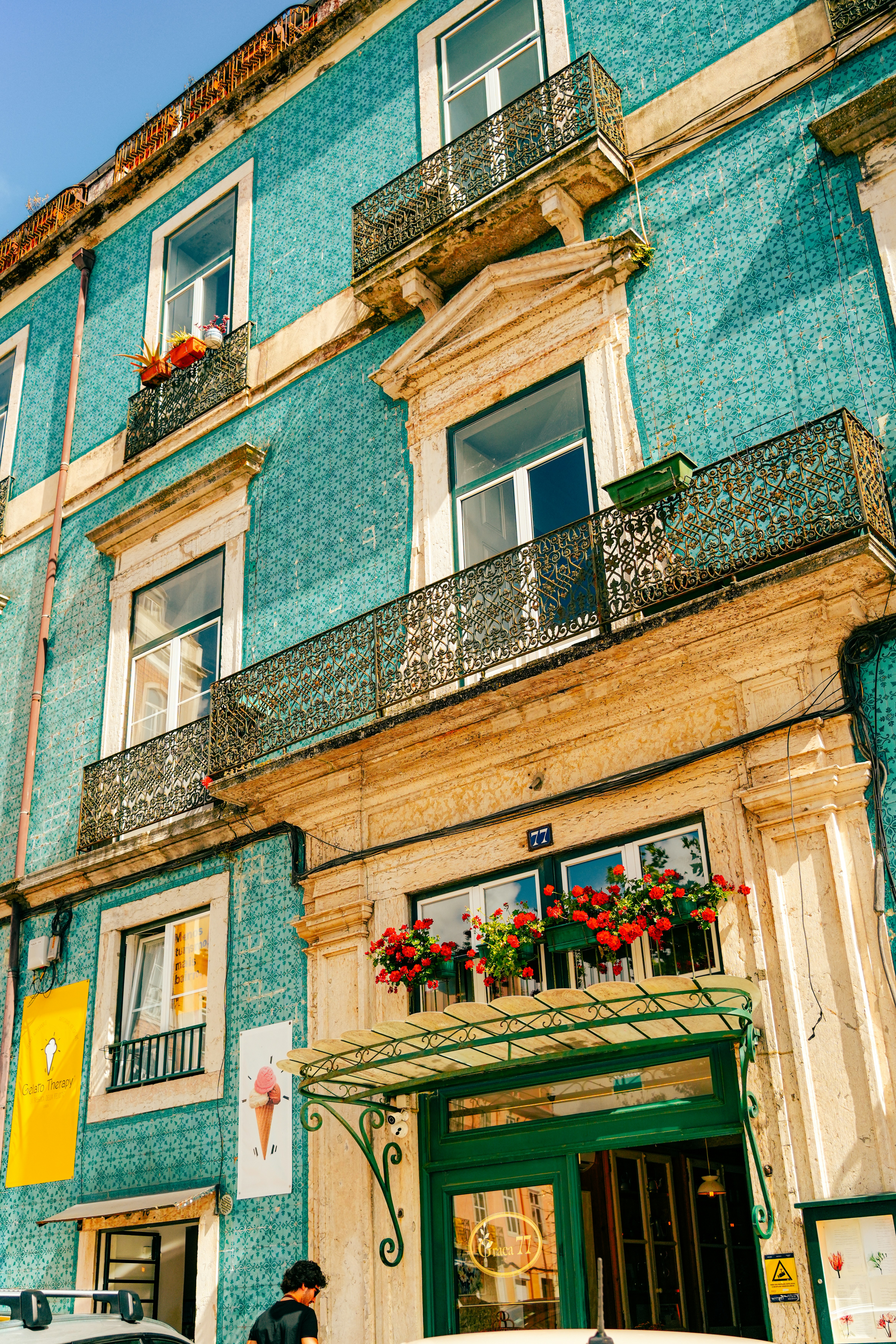 Turquoise Facade, Ironwork and Flowered Portal