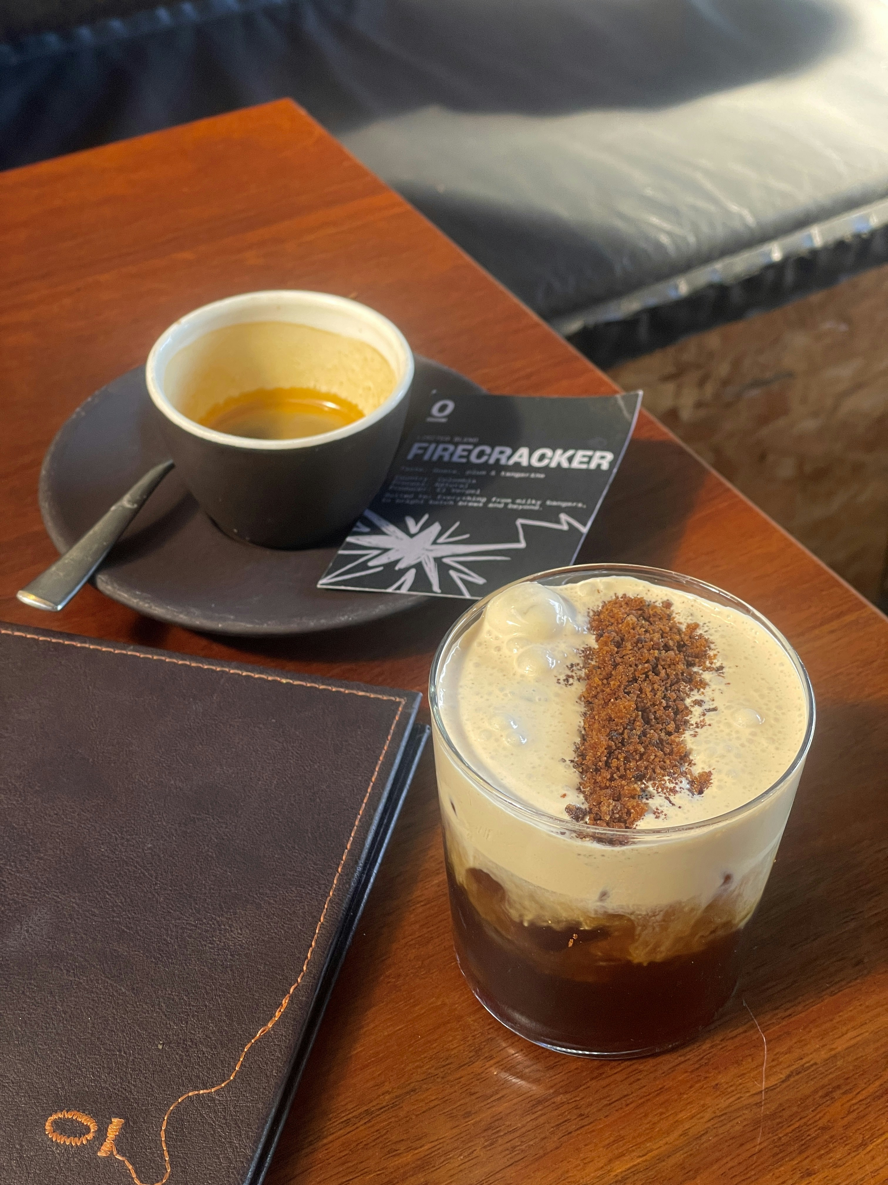 Two Desserts on a Wooden Table: Espresso Cup and Layered Chocolate Drink