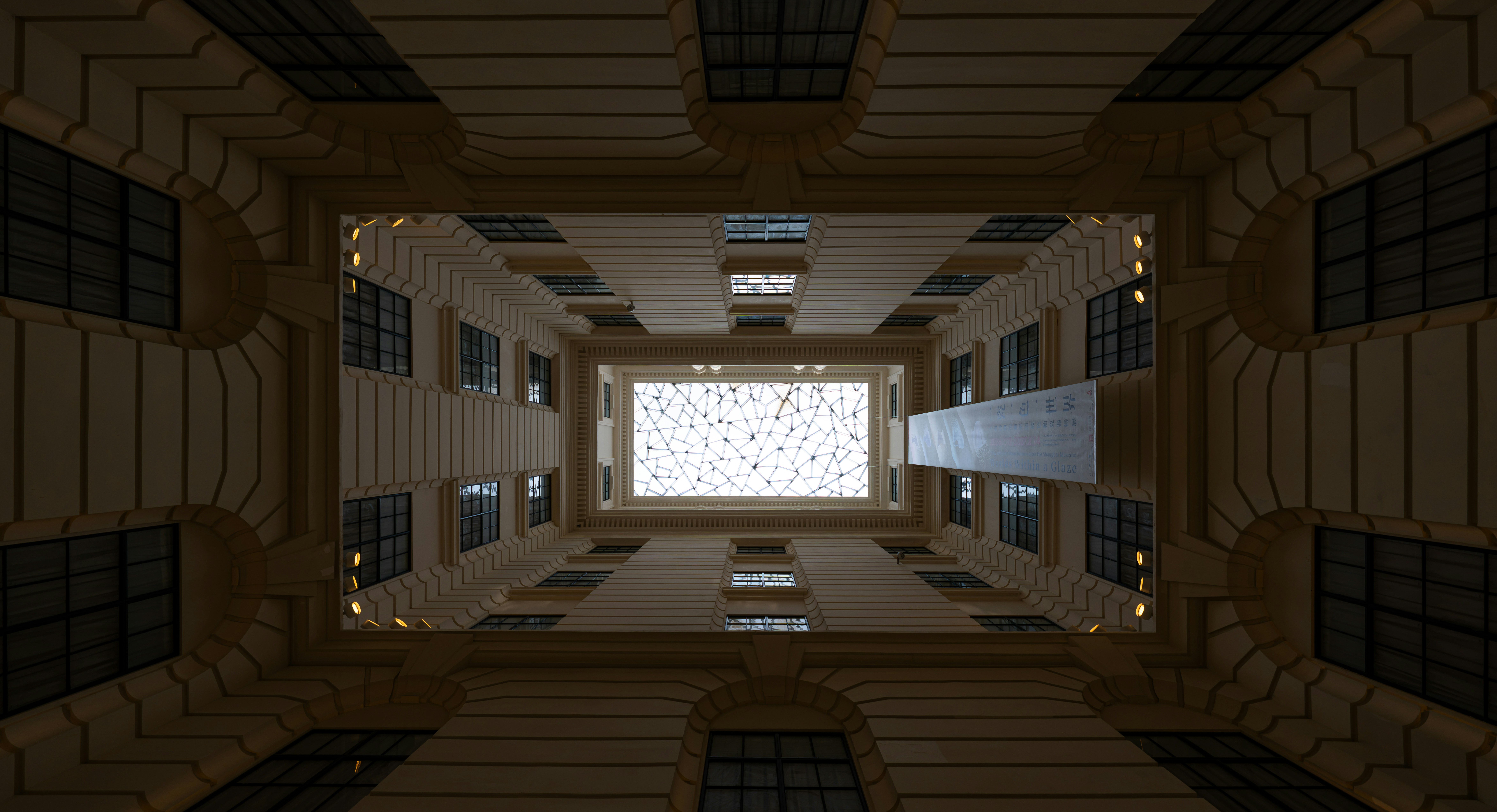 Vertical Courtyard: A Rectangular Skyward Atrium Framed by Narrow Windows