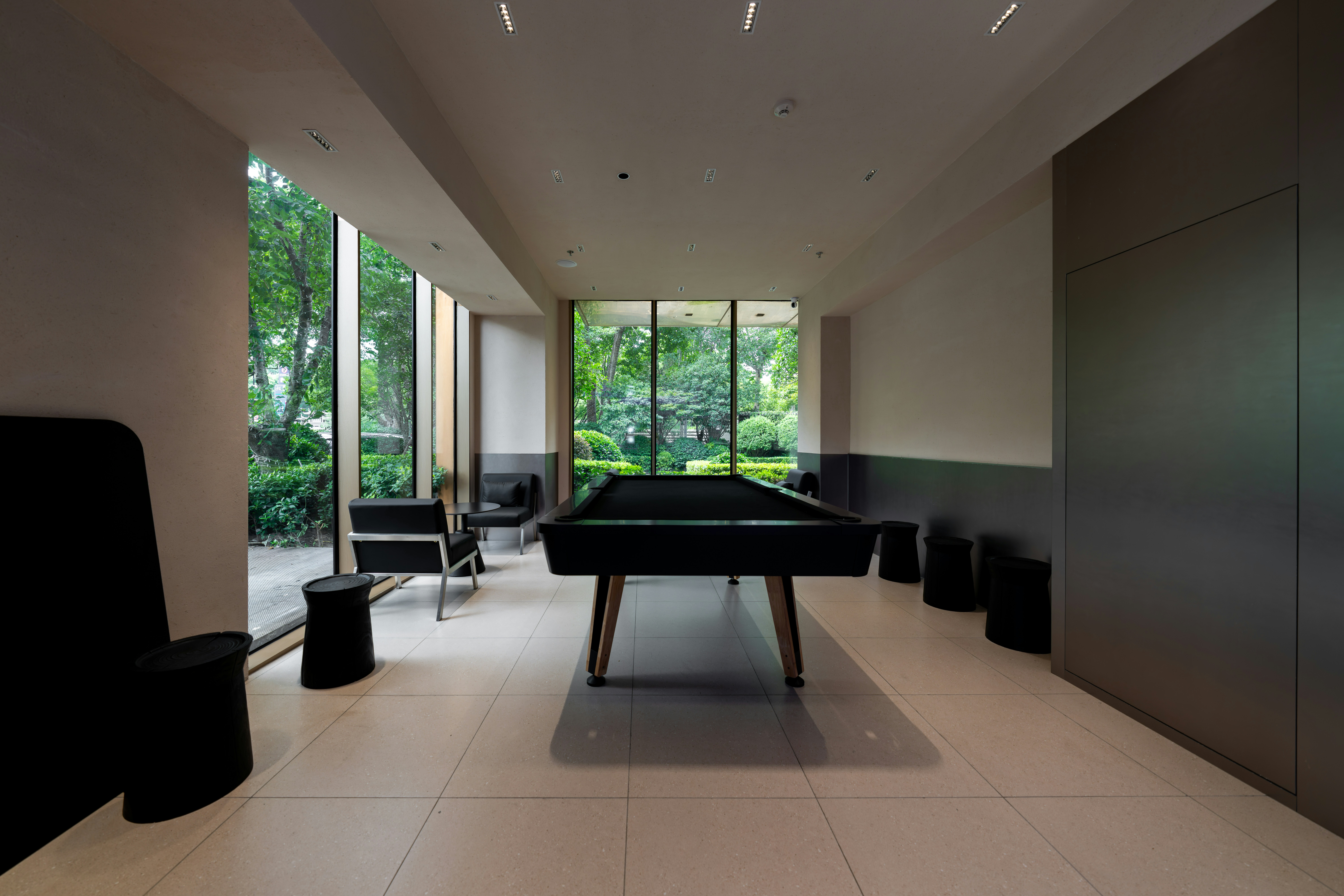 Pool-Top Billiards Room Framed by Floor-to-Cloor Windows