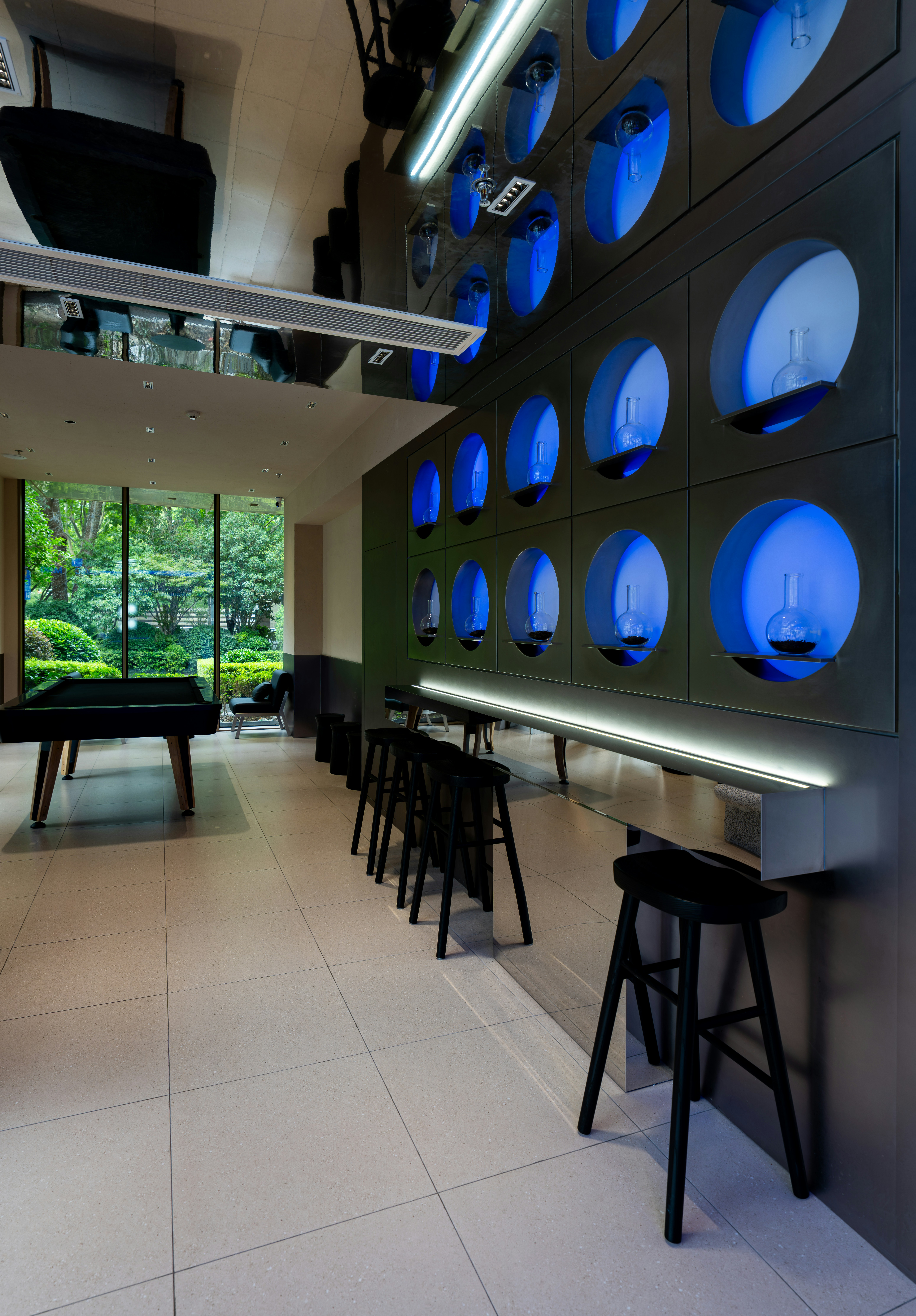 Blue-lit Pod Wall Overhang in Modern Lounge