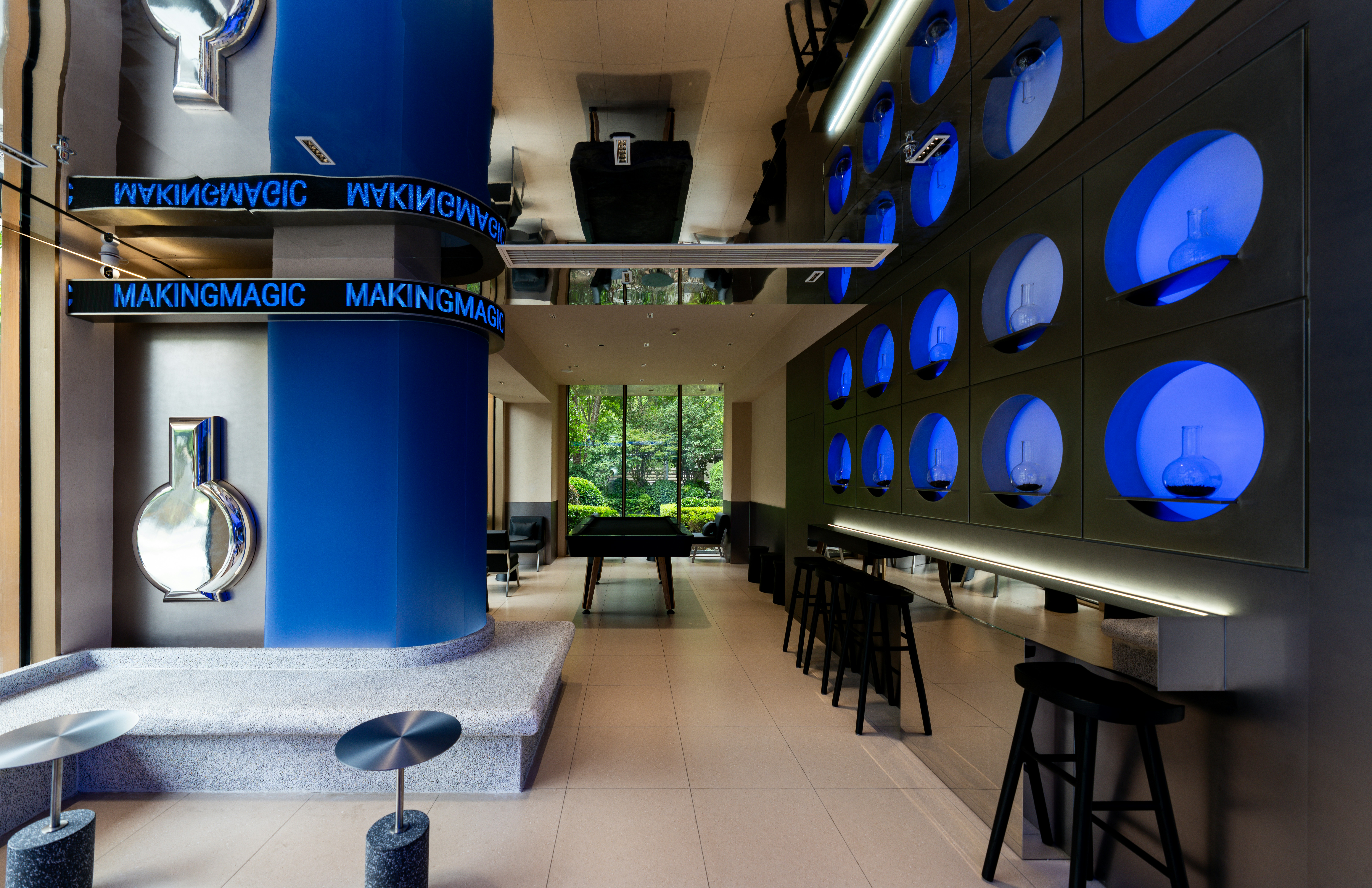 Blue Orbits and Glass Lounges: A Modern Café Corridor