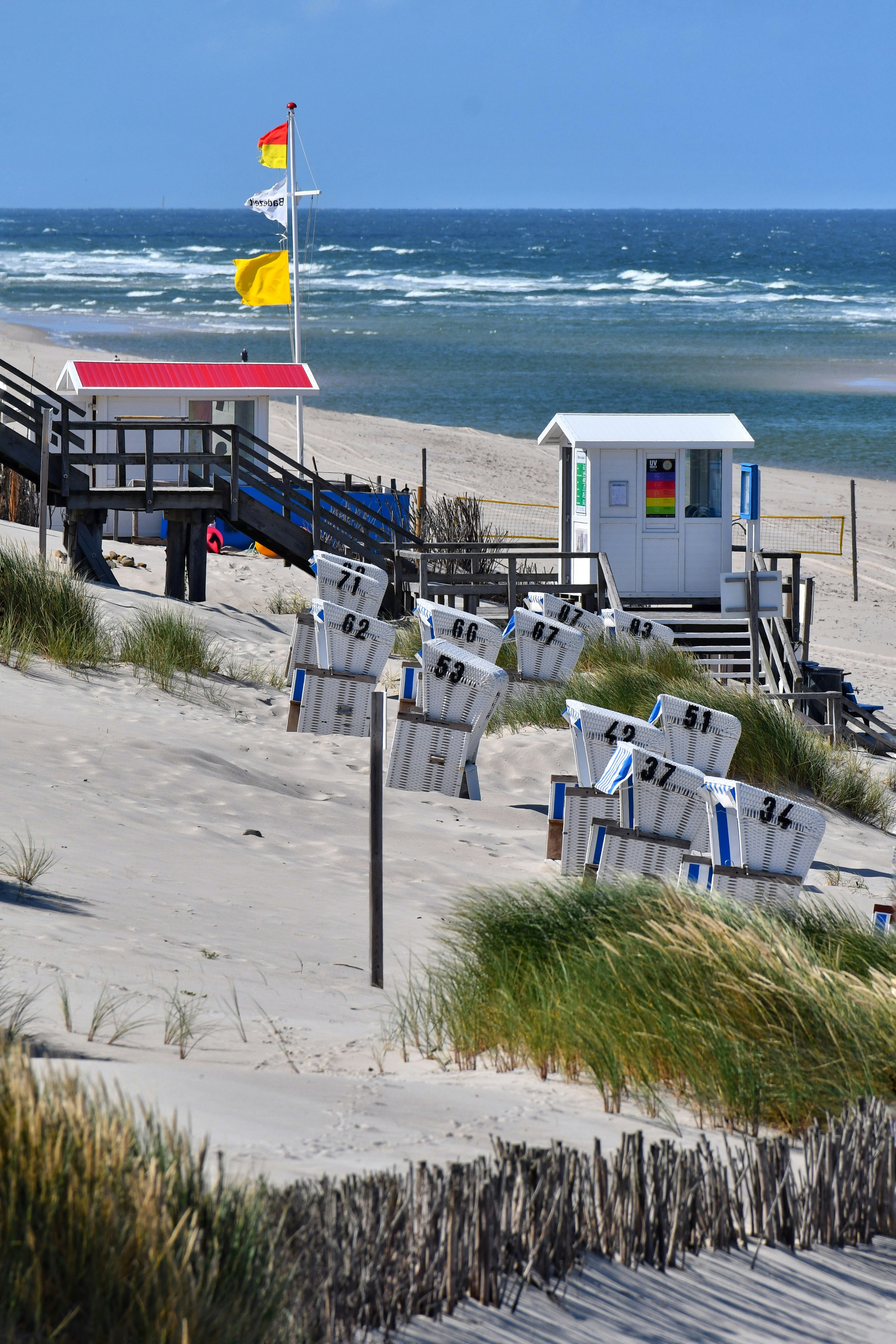 Lifeguard Station and Beach Chairs on a Sunlit Dune
