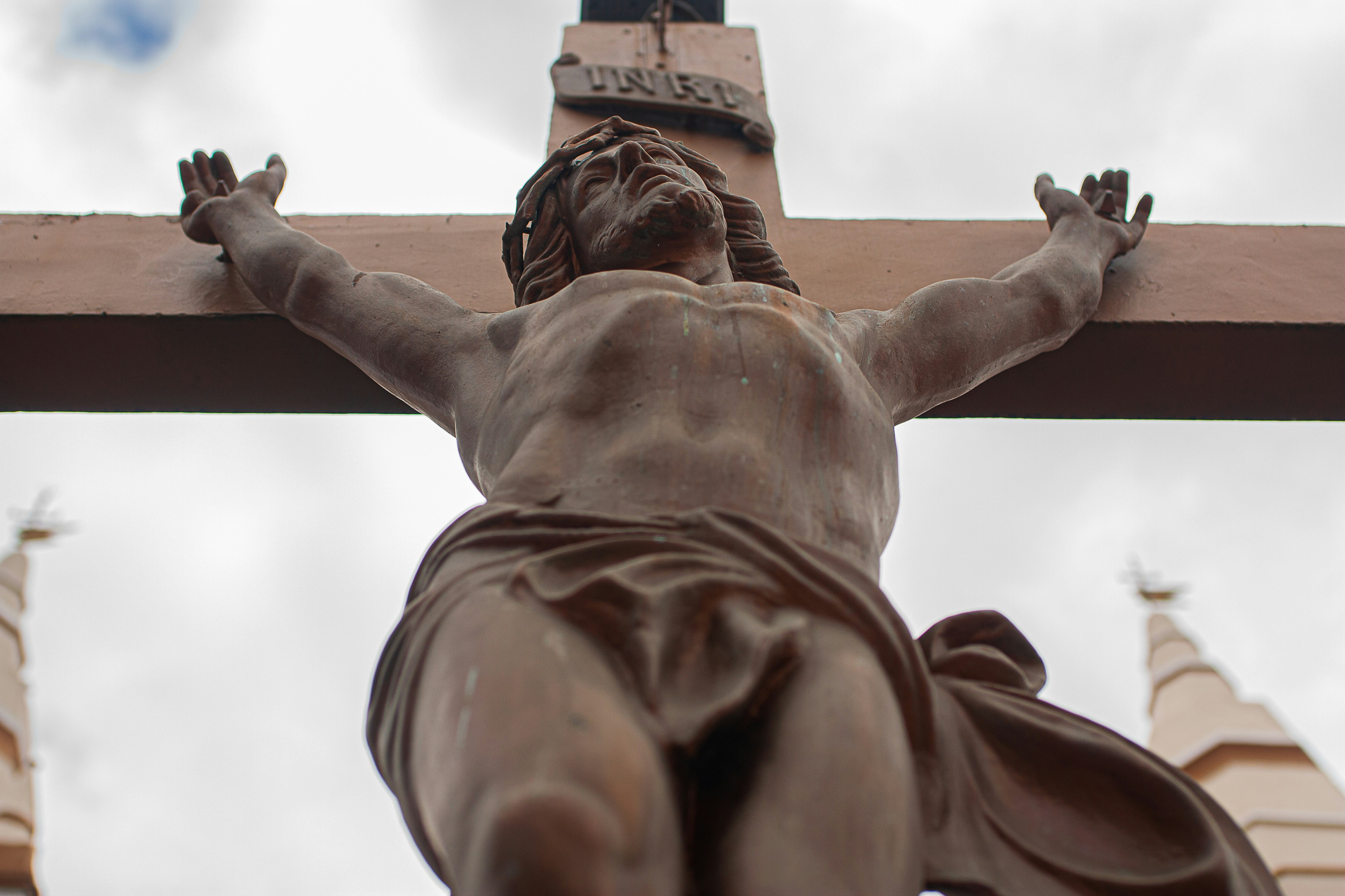 Cruciform Sentinel: A Low-Angle Glimpse Under the Cross