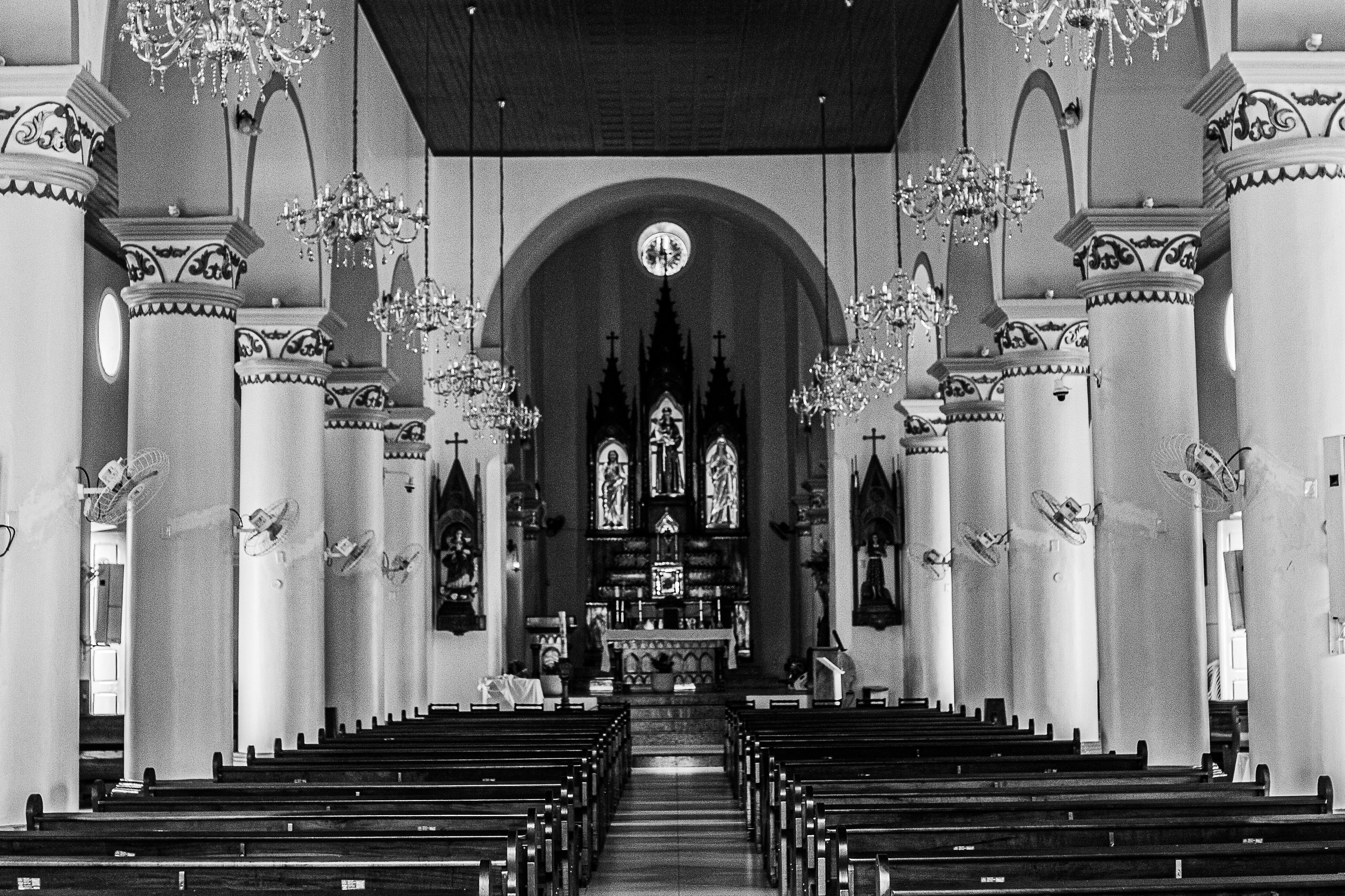 Quiet Nave with Altarpiece Echoes in Black and White