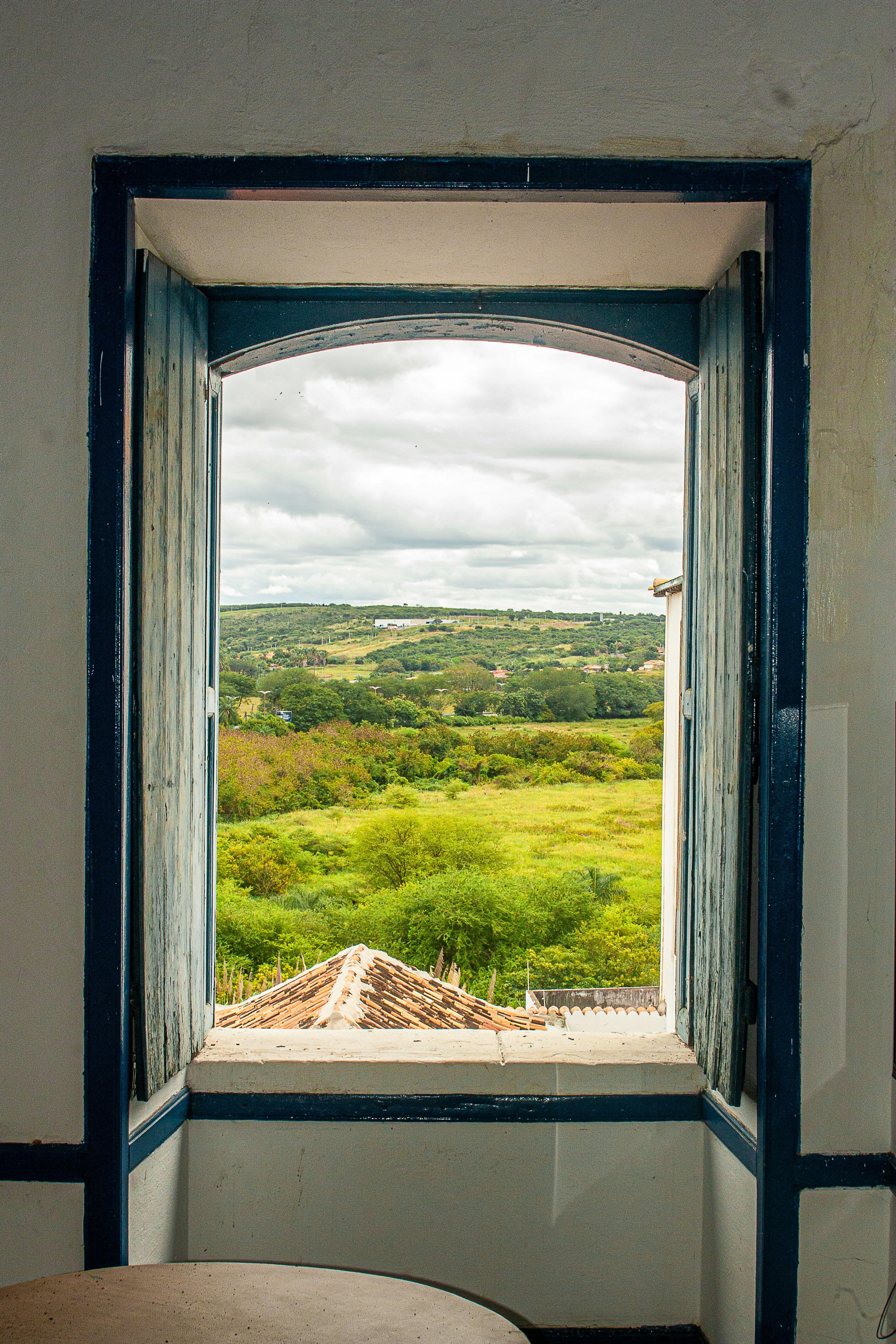 Doorway to the Valleys: Framed Landscape from a Weathered Window
