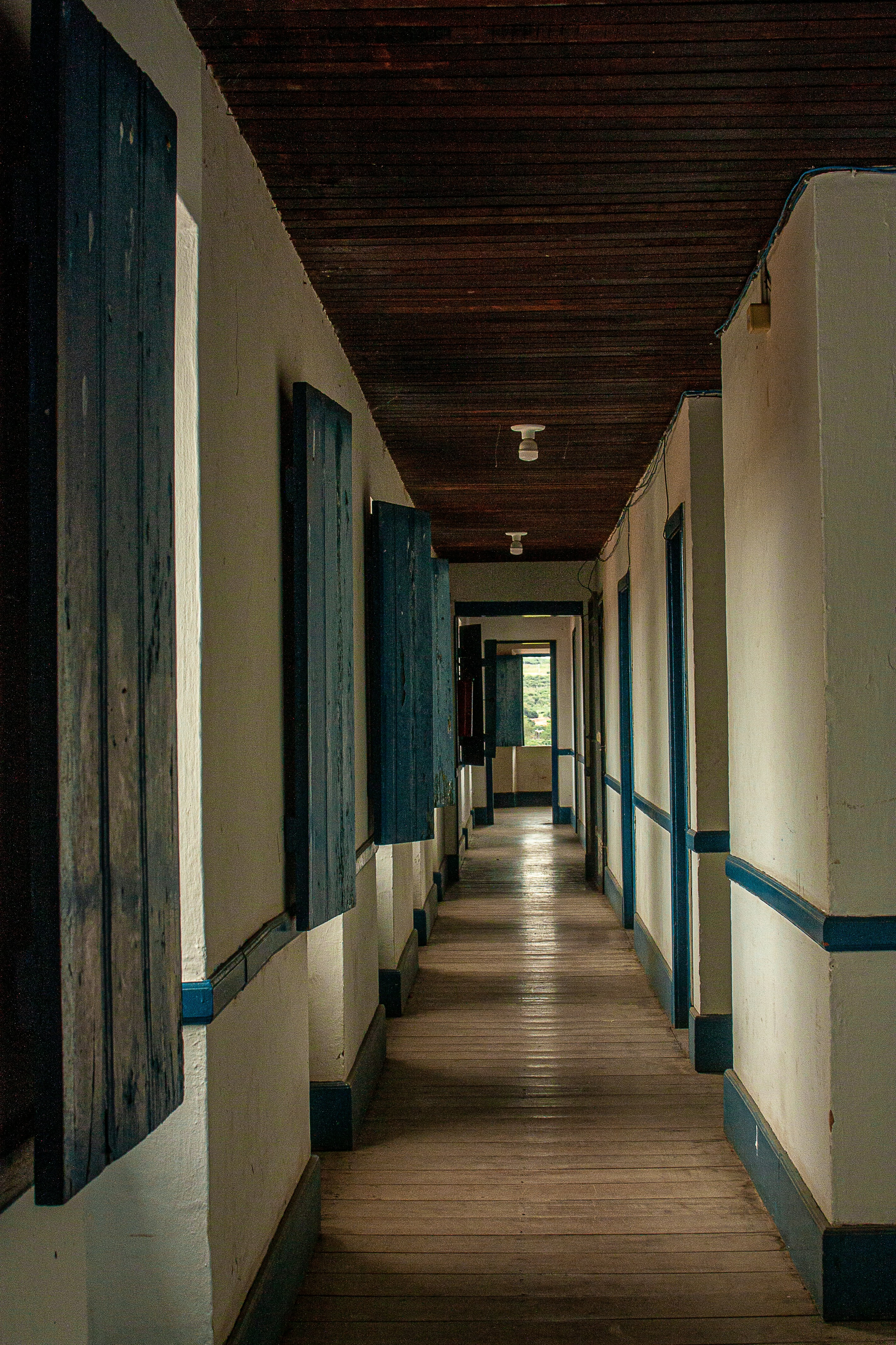 Long Corridor of Quiet Light: A Distant Doorway at the End of the Hall