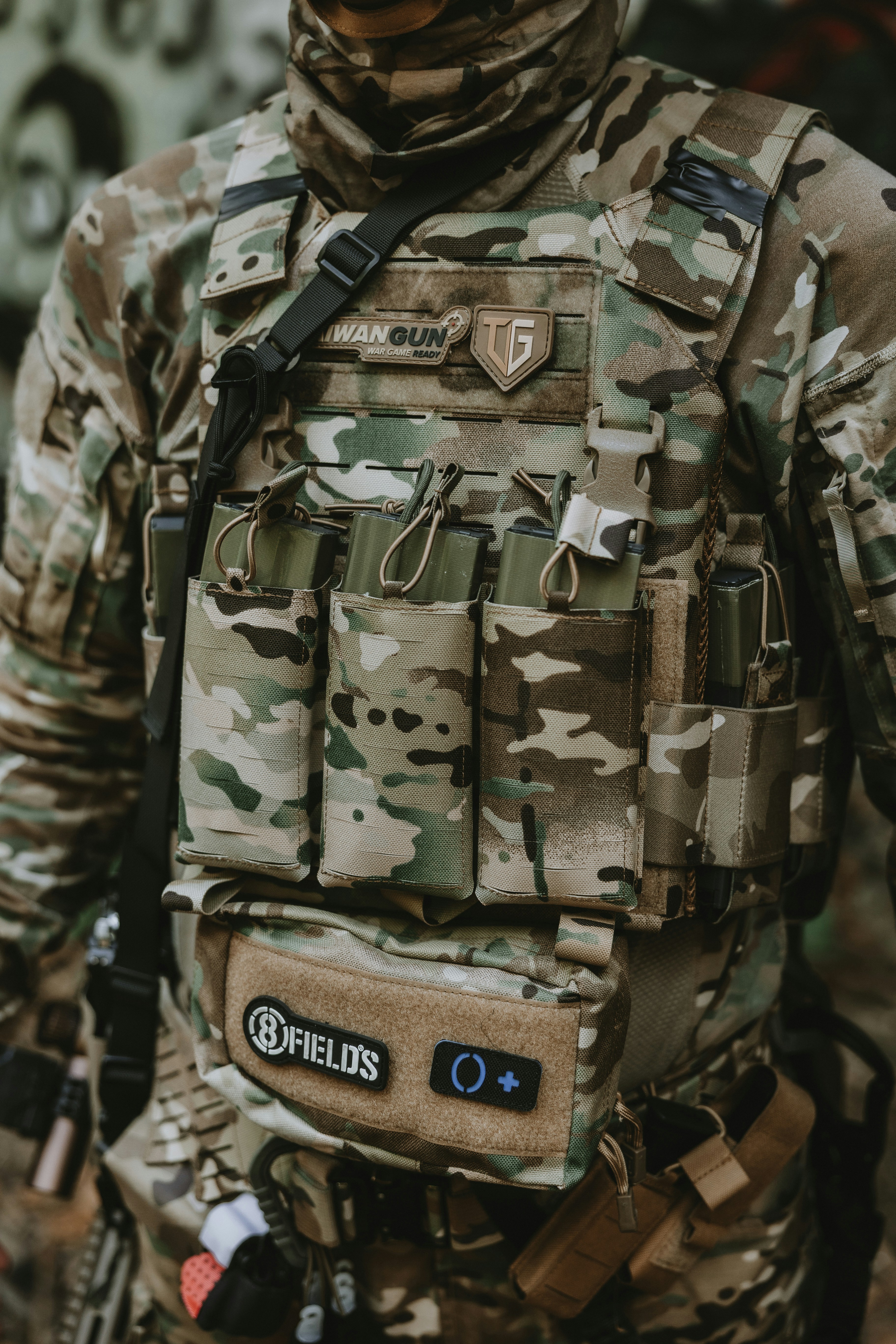 Camouflage Ready: Tactical Loadout Amid Forest Backdrop