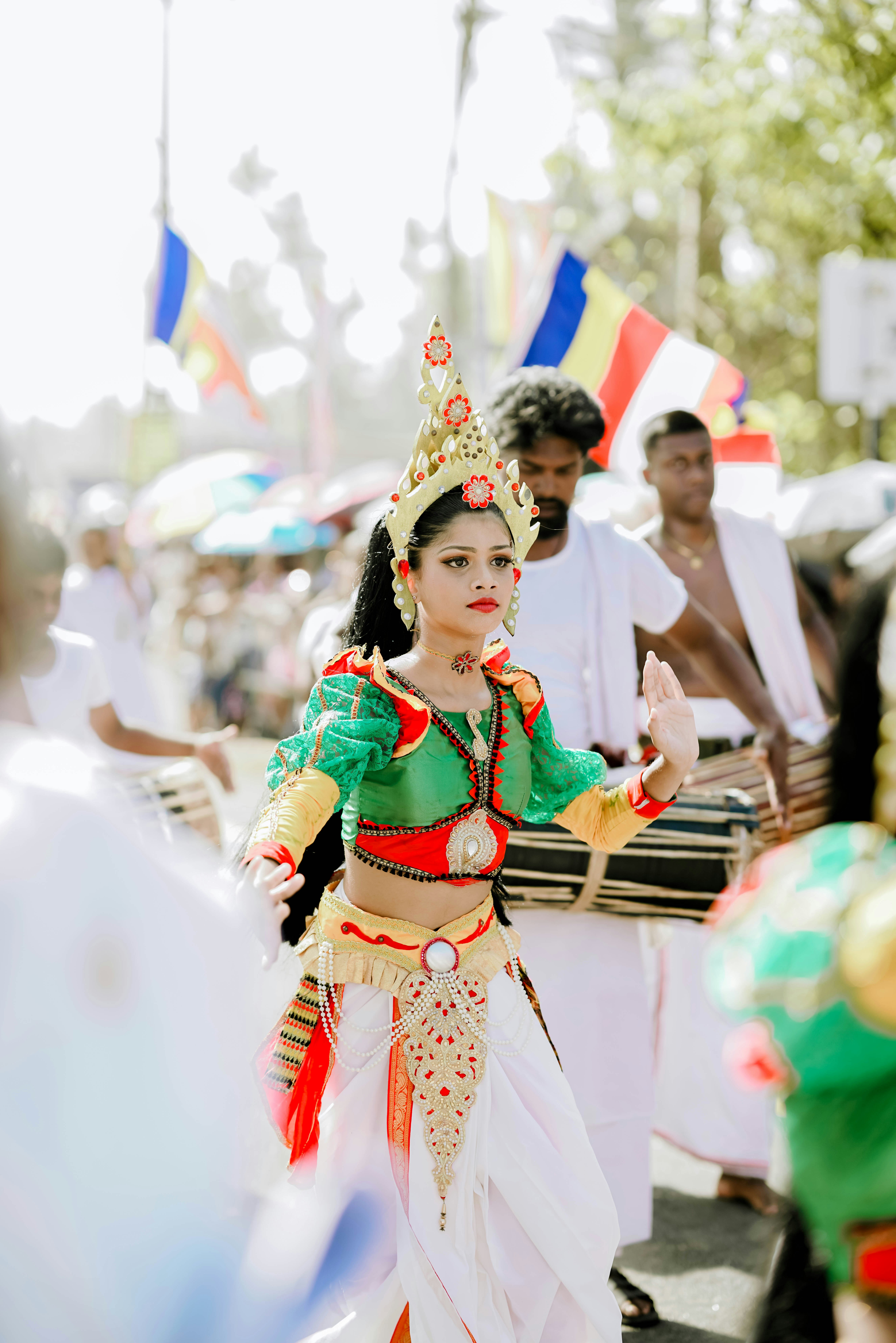  dancer in vibrant traditional attire leads a festive street procession