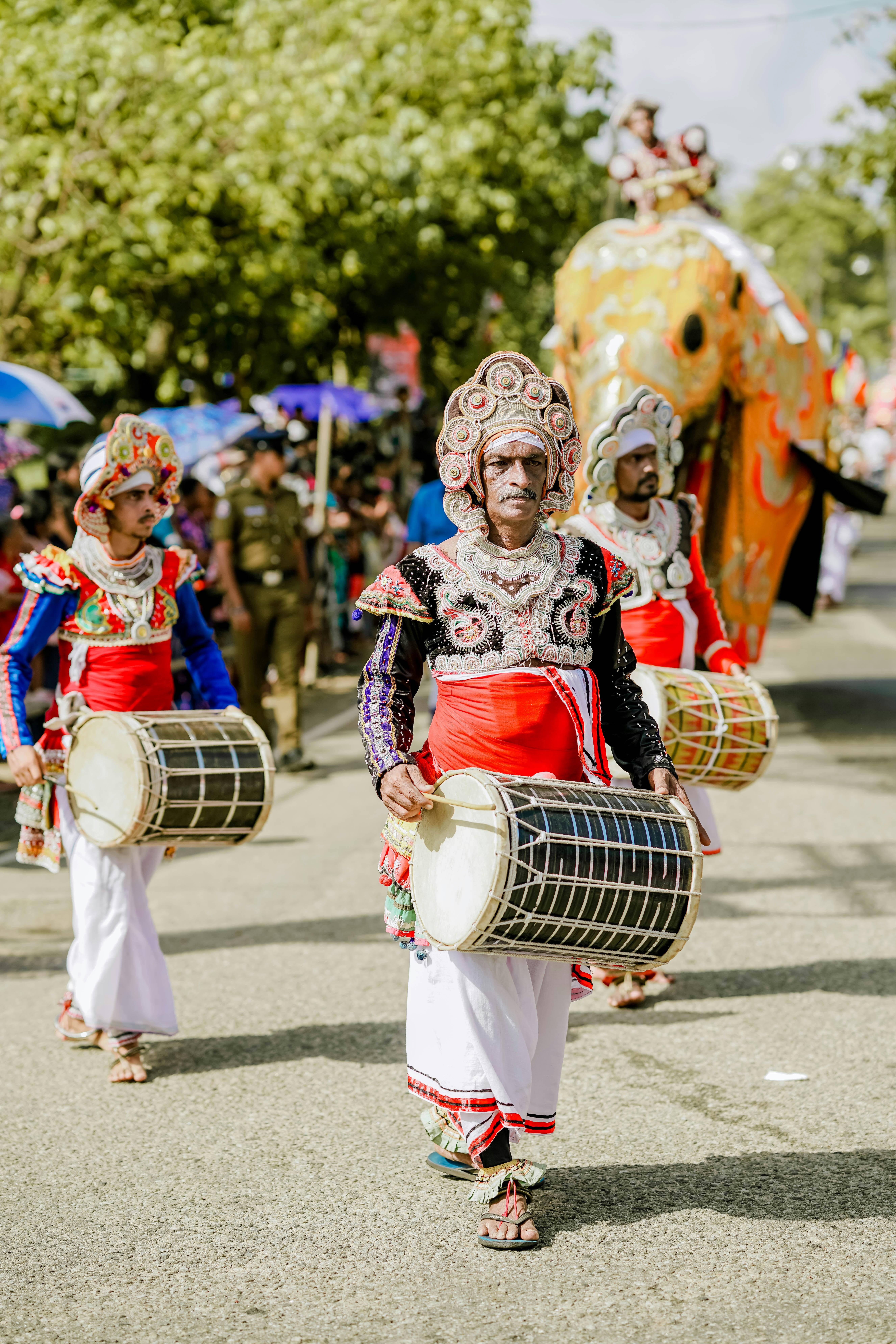 Drummers in Ornate Costumes Lead a Festive Parade