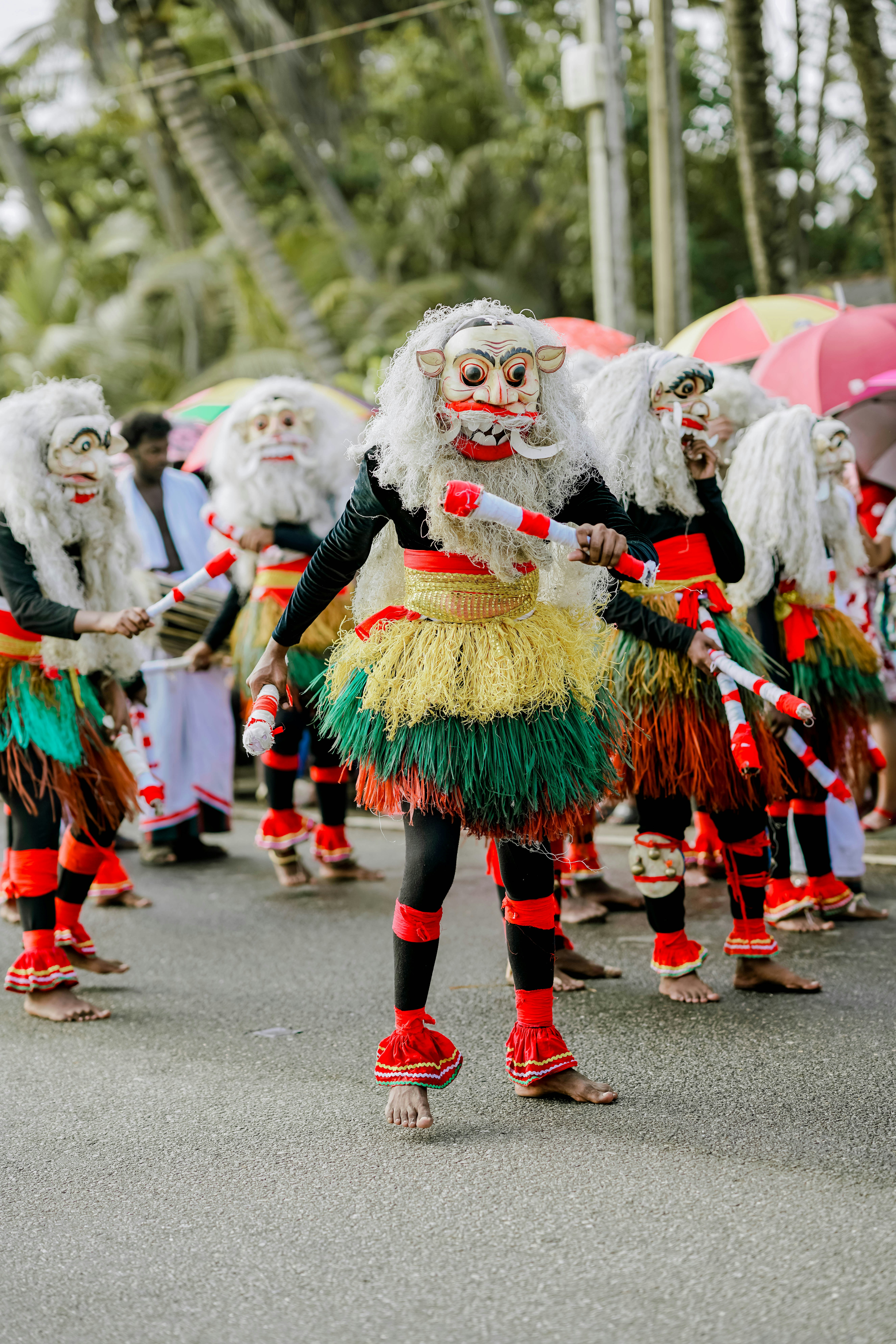 Masked Dancers in Colorful Grass Skirts Ignite the Street