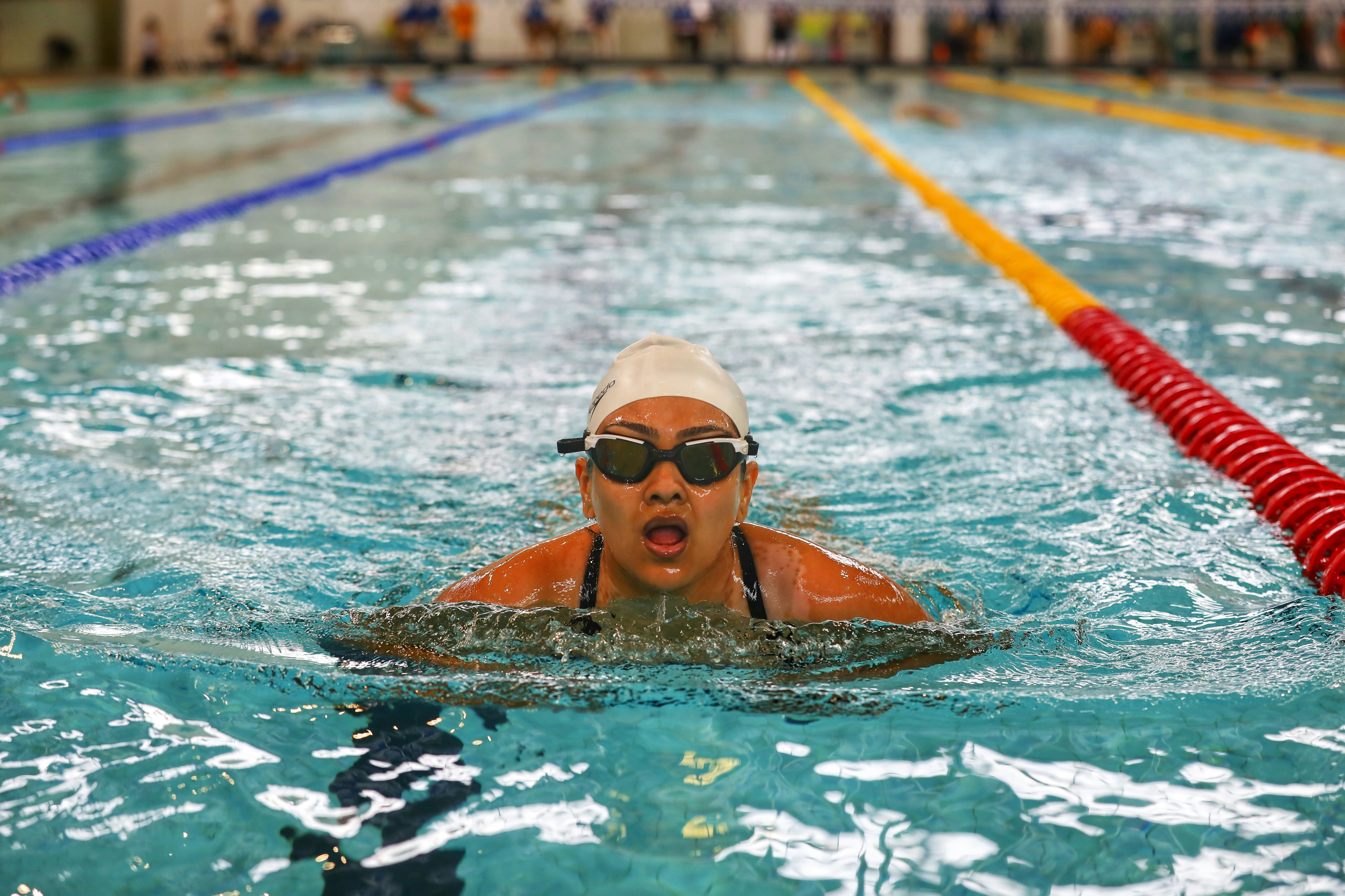 Mid-Pool Focus: Swimmer Breathing Lift at an Indoor Lap Pace