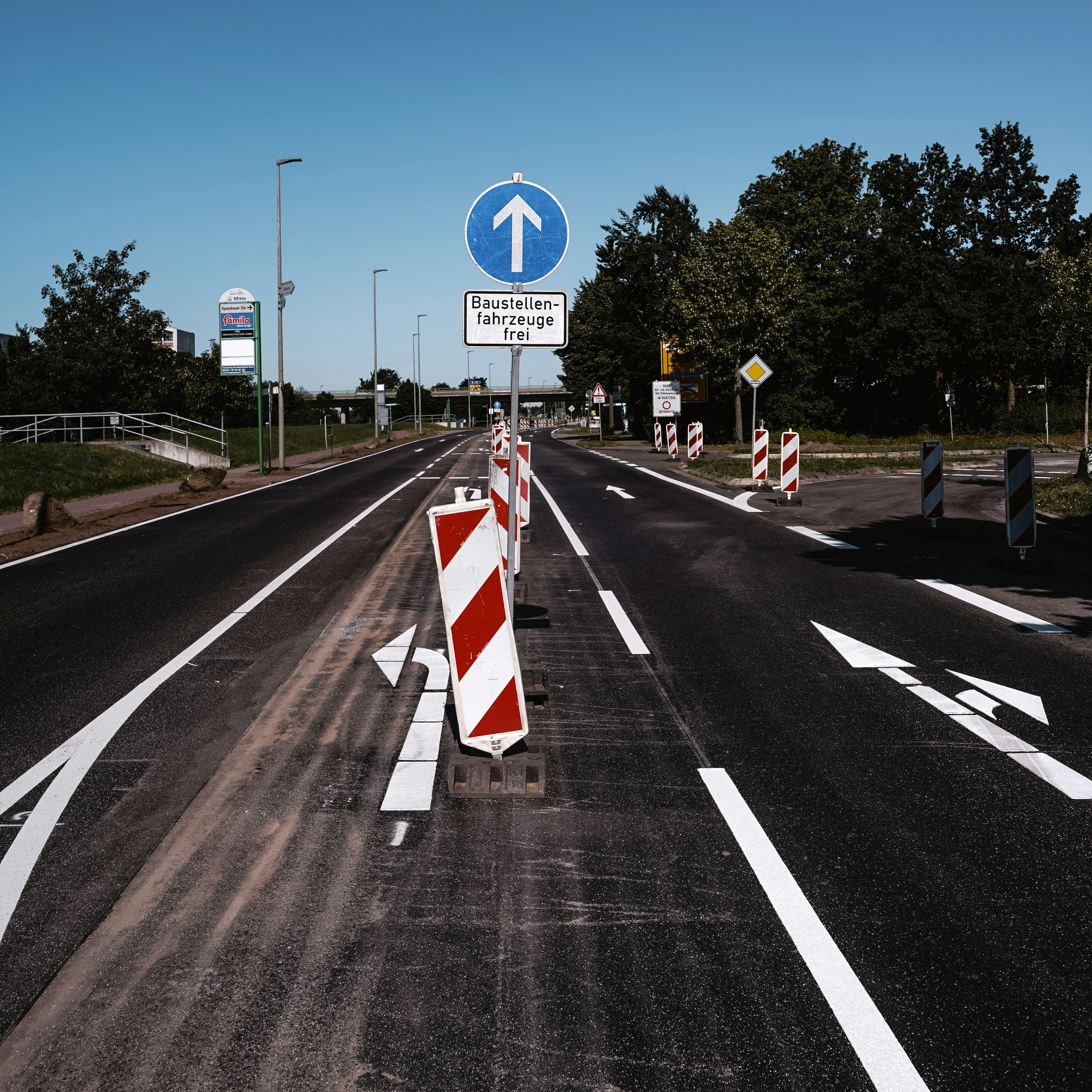 Mid-Construction Avenue: A Stripe of Progress Under a Clear Sky