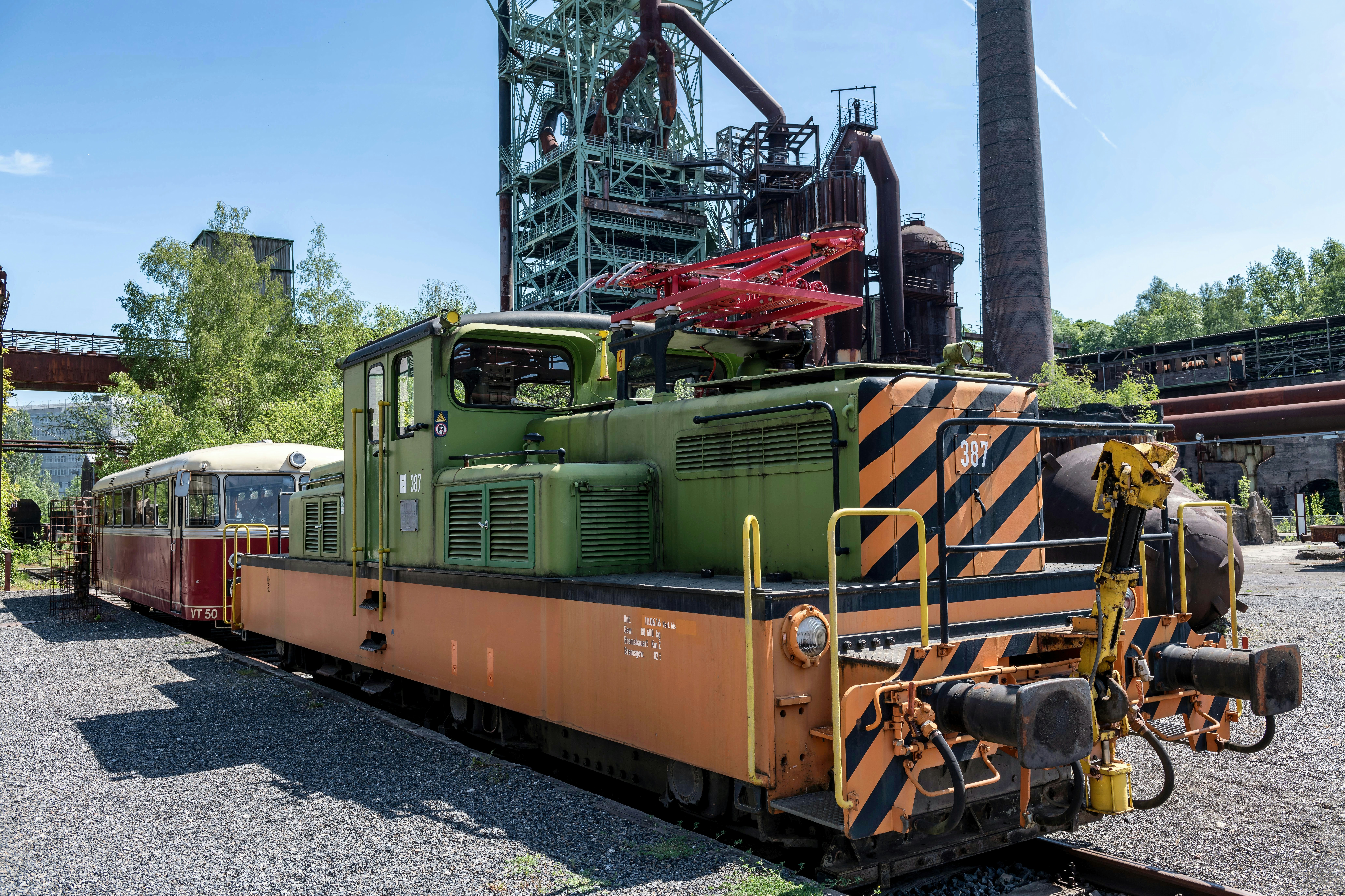 A Green Industrial Locomotive Guards the Yard at Midday