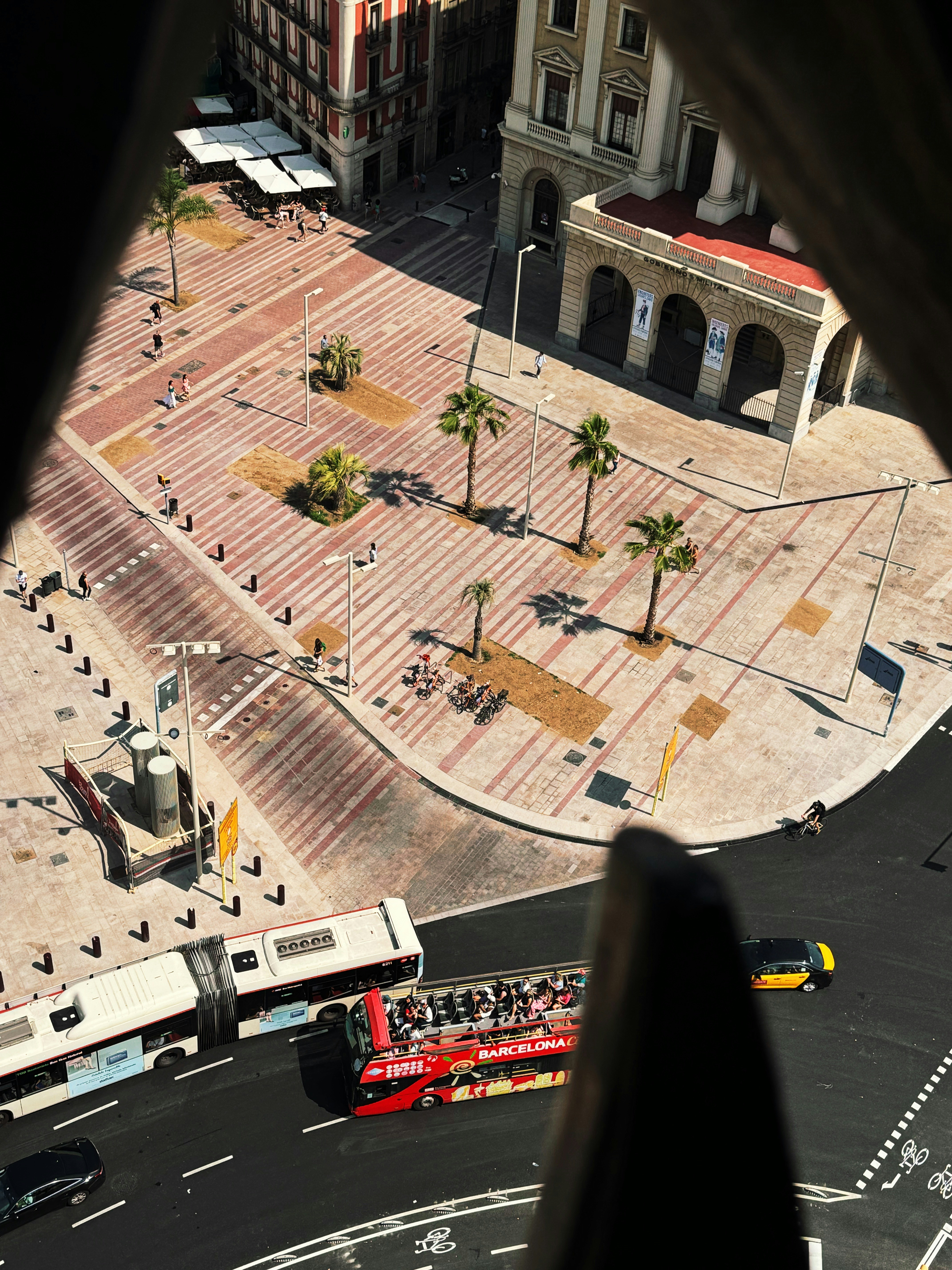Aerial plaza pulse: urban terrace and tram below