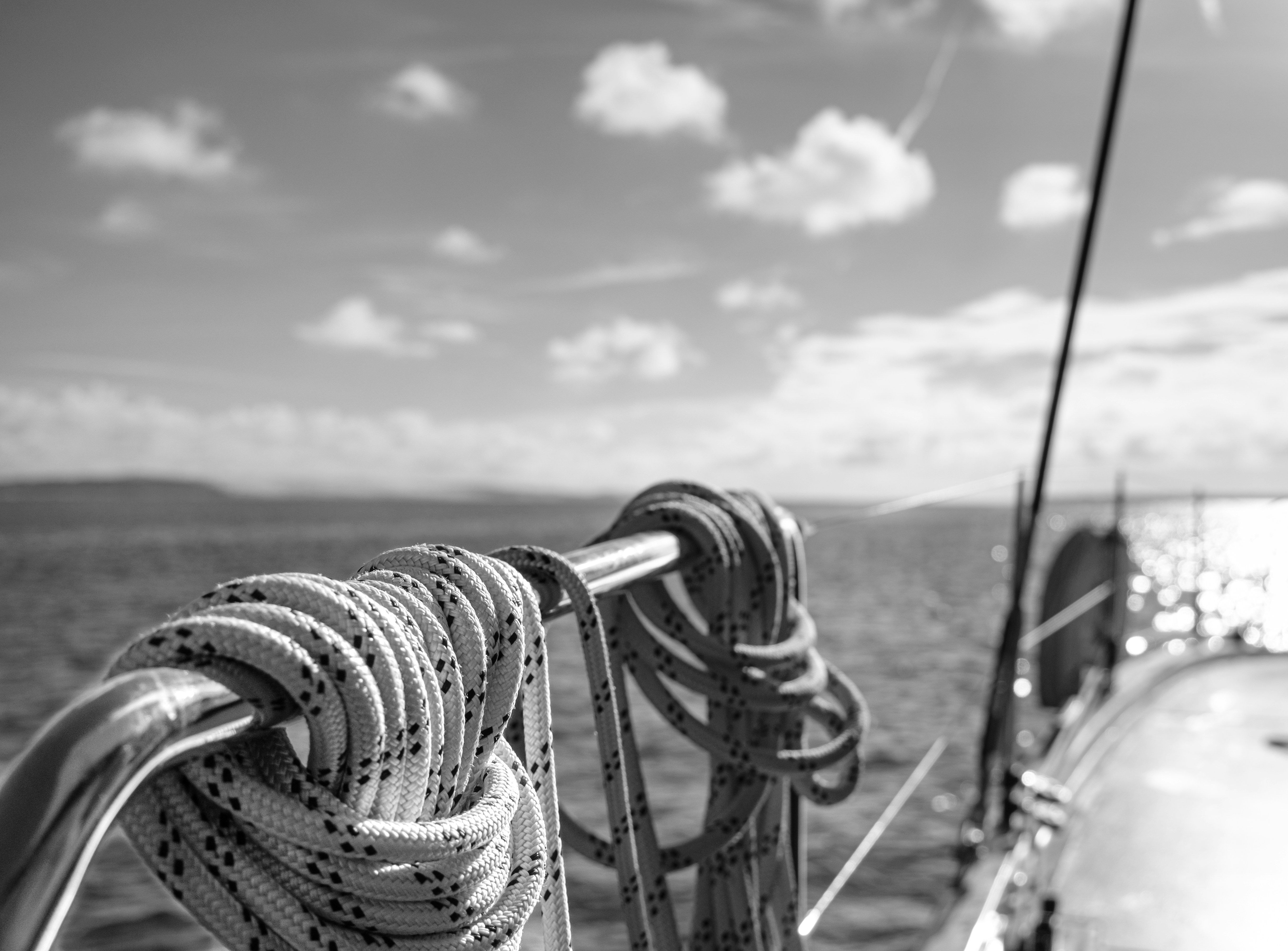 Rope and Mast Lines: A Quiet Sea Rests Behind Coiled Cables