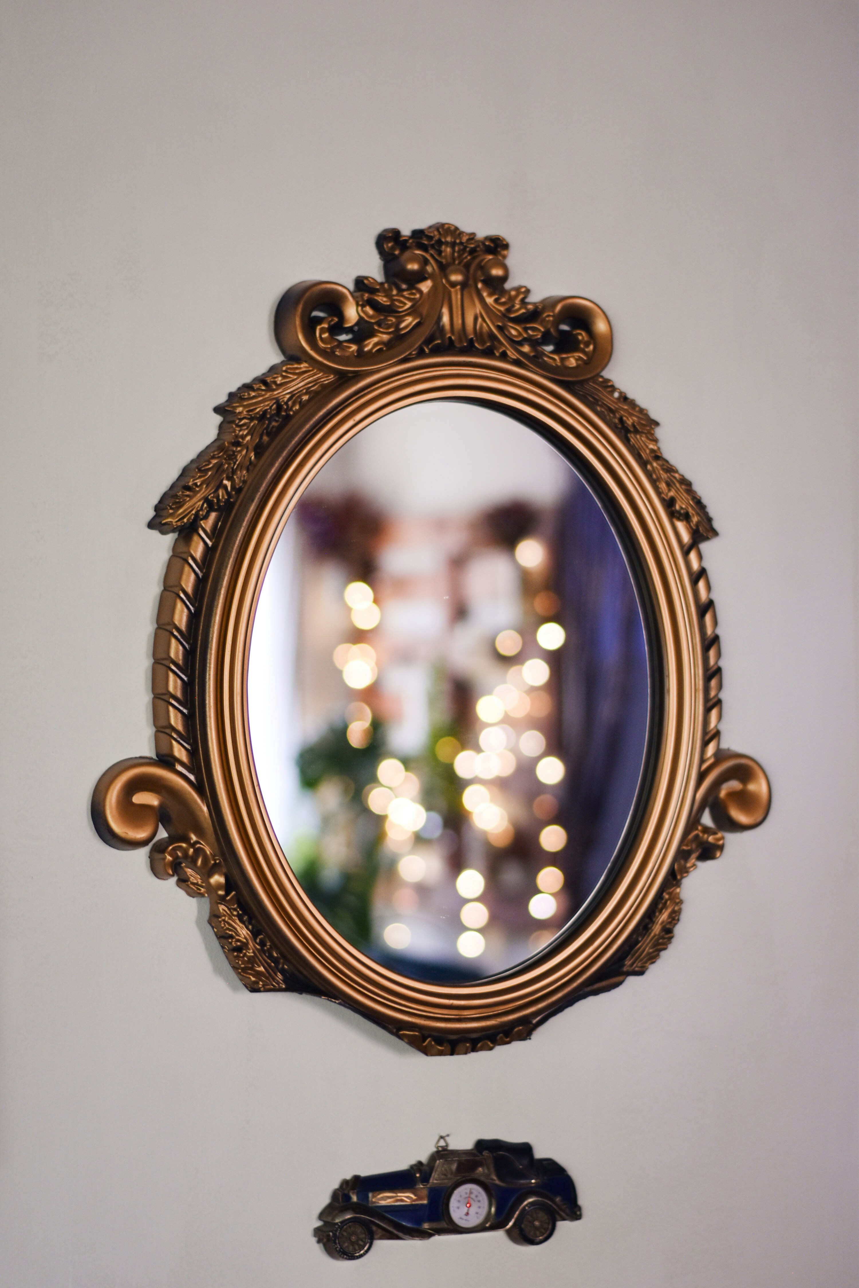 Ornate Mirror, Soft Bokeh Lights, and a Toy Car