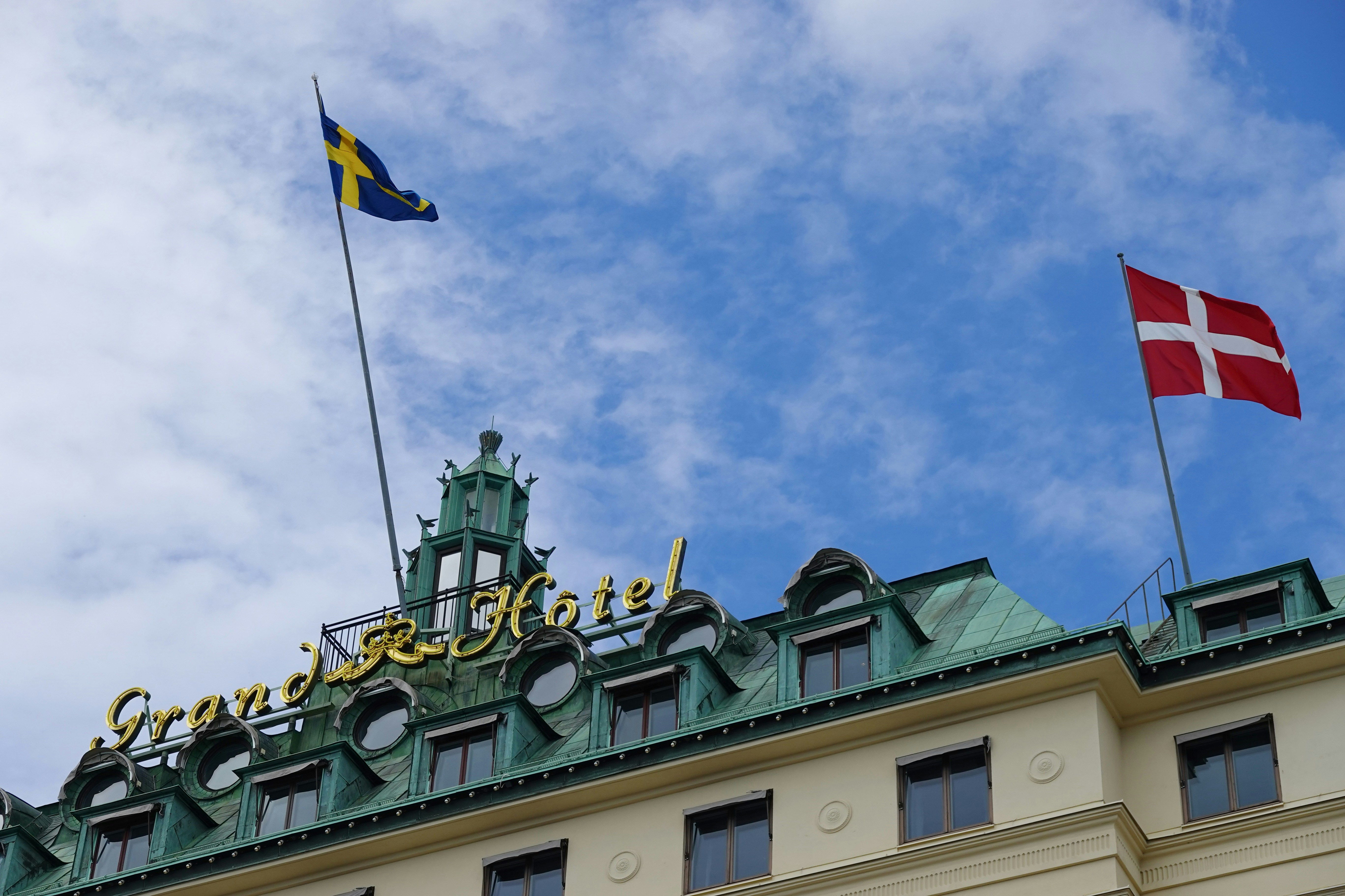 Flag-Rimmed Roofline: Grand Hotel Awash in Nordic Sky