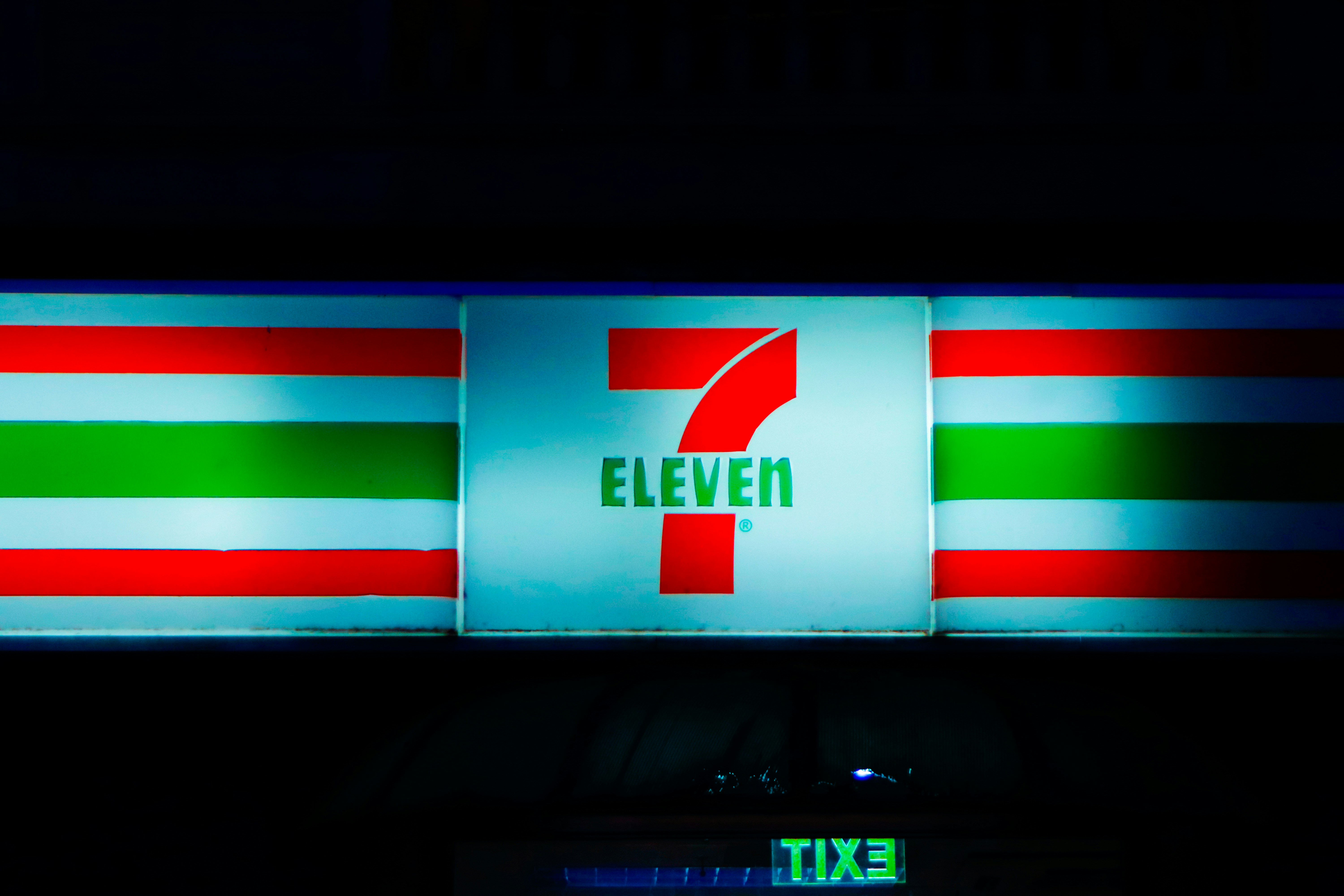 Neon Seven-Eleven Sign Illuminates a Quiet Night