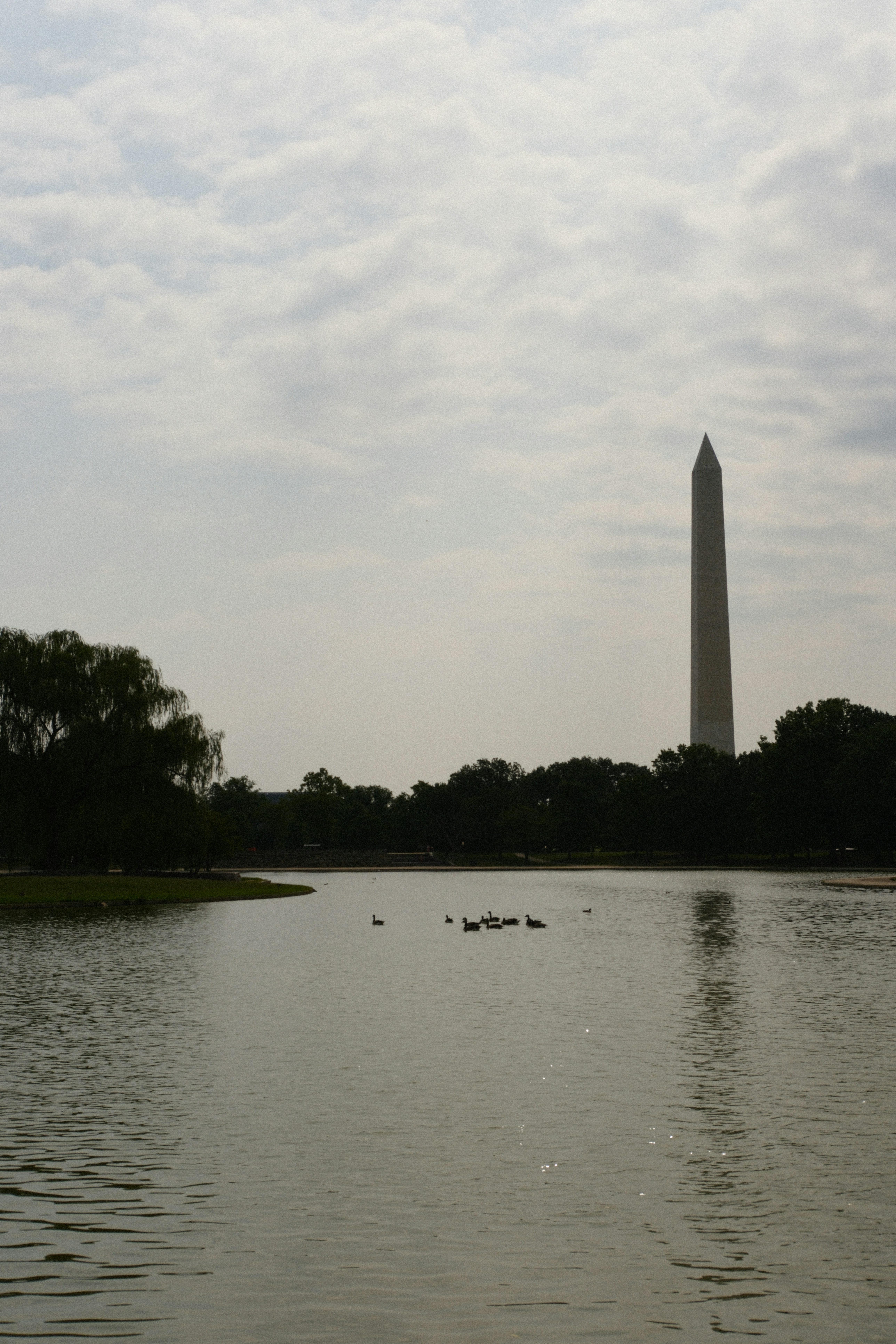 Obelisk Silhouette Over Reflective Lake