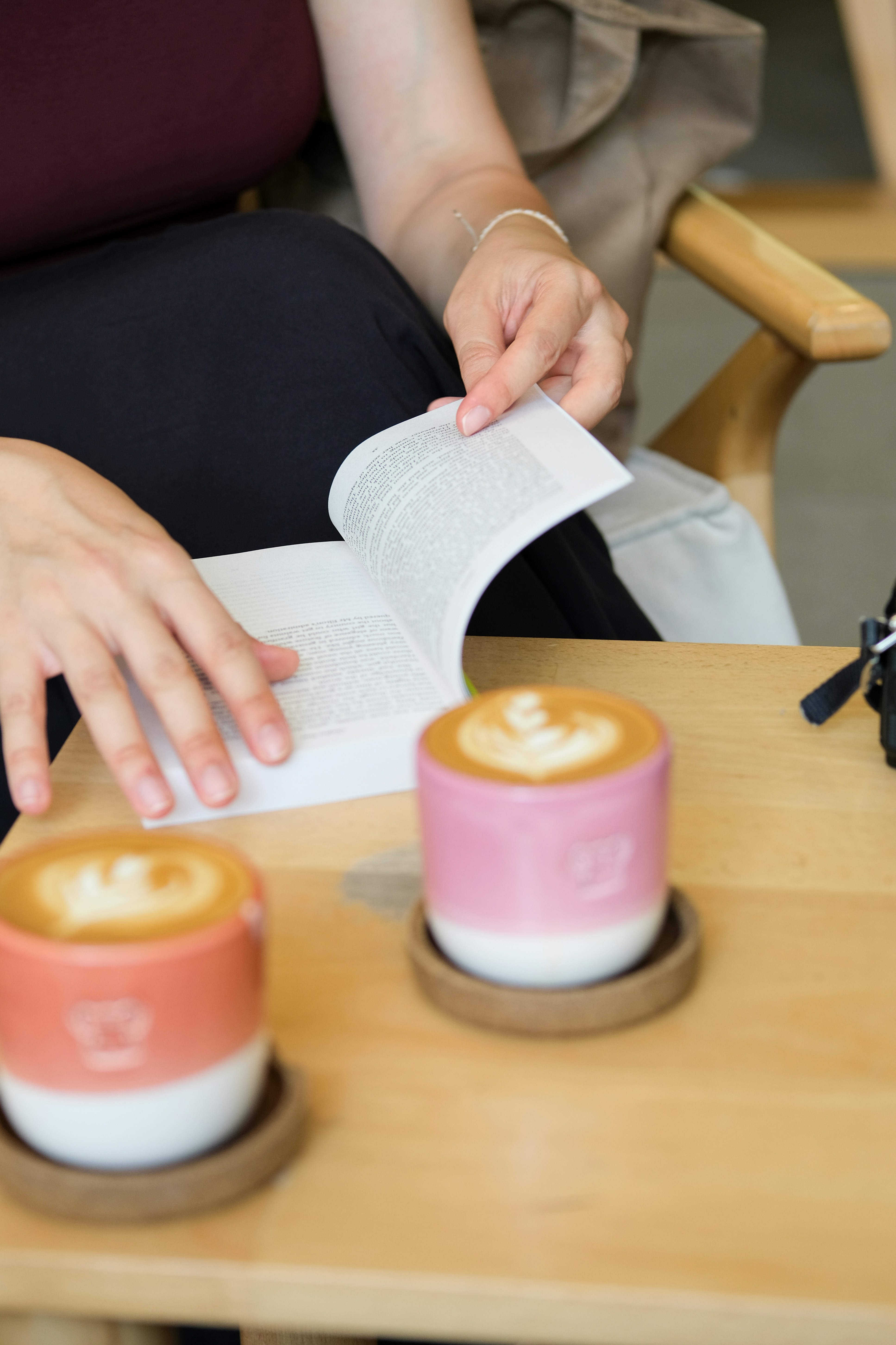 Hands in Focus: Reading a Page Over Two Latte Candles