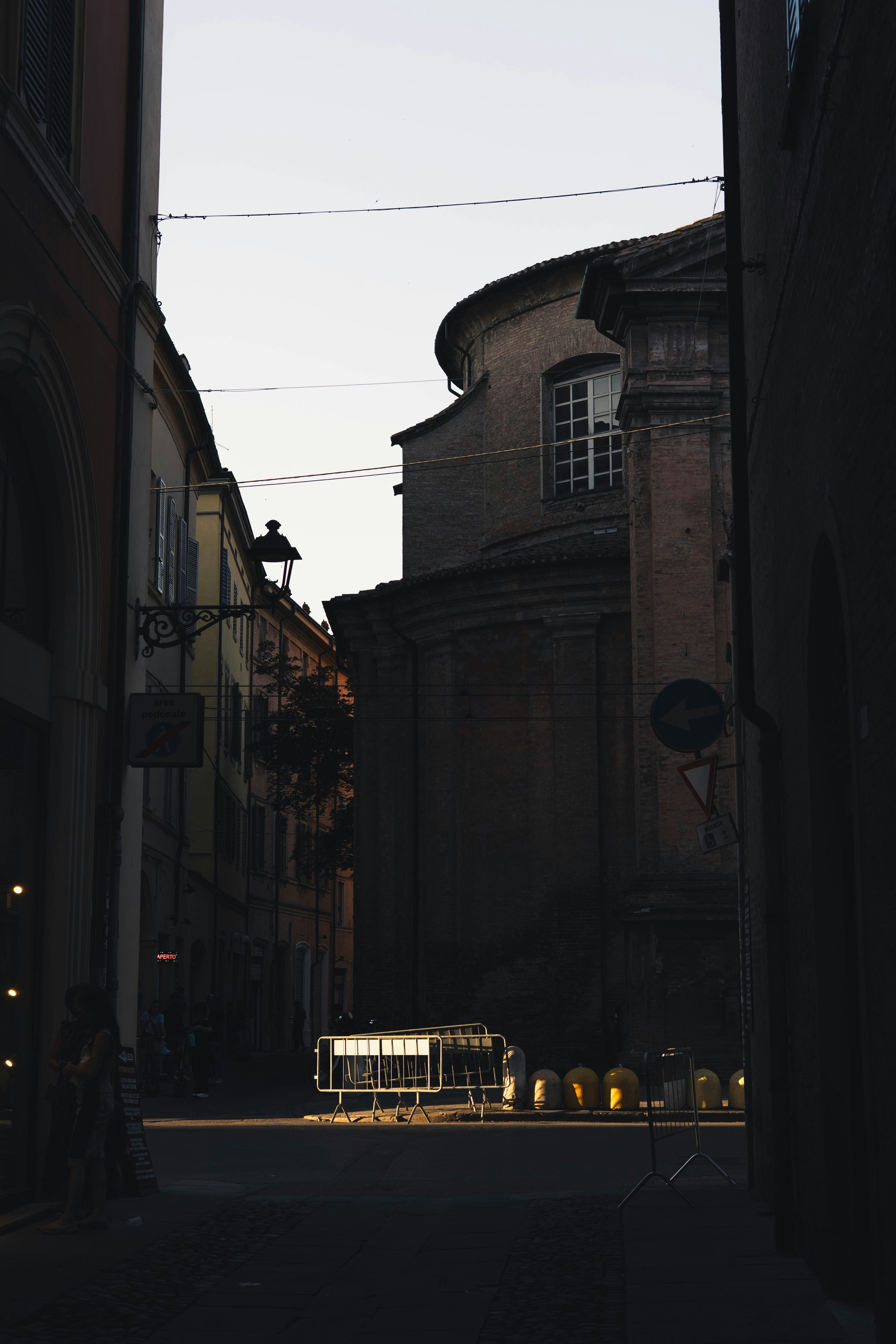 Silhouetted Street Lanterns and Historic Facade in Dusk Corridor