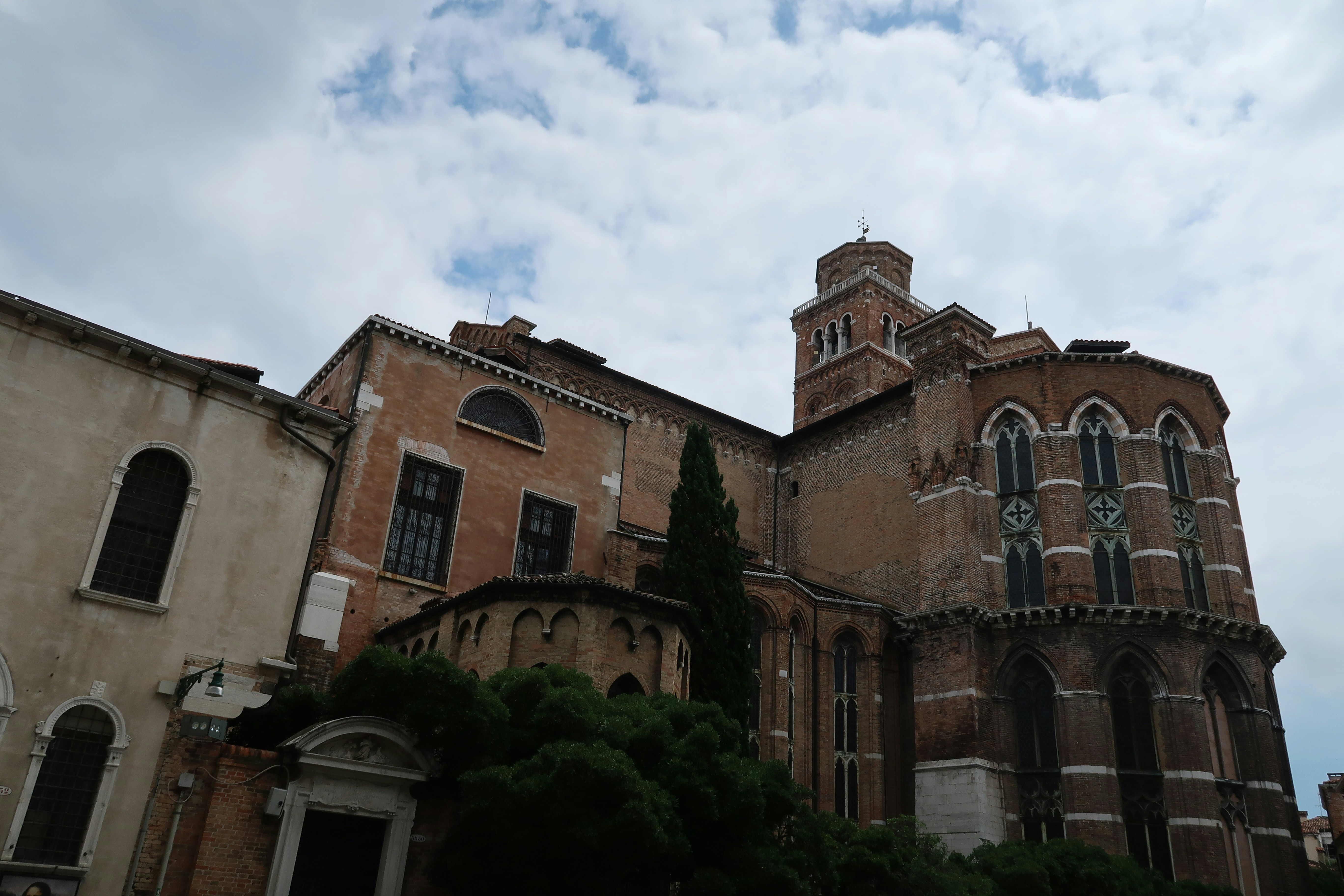 Brick-and-arched Cathedral Facade under a Patch of Sky