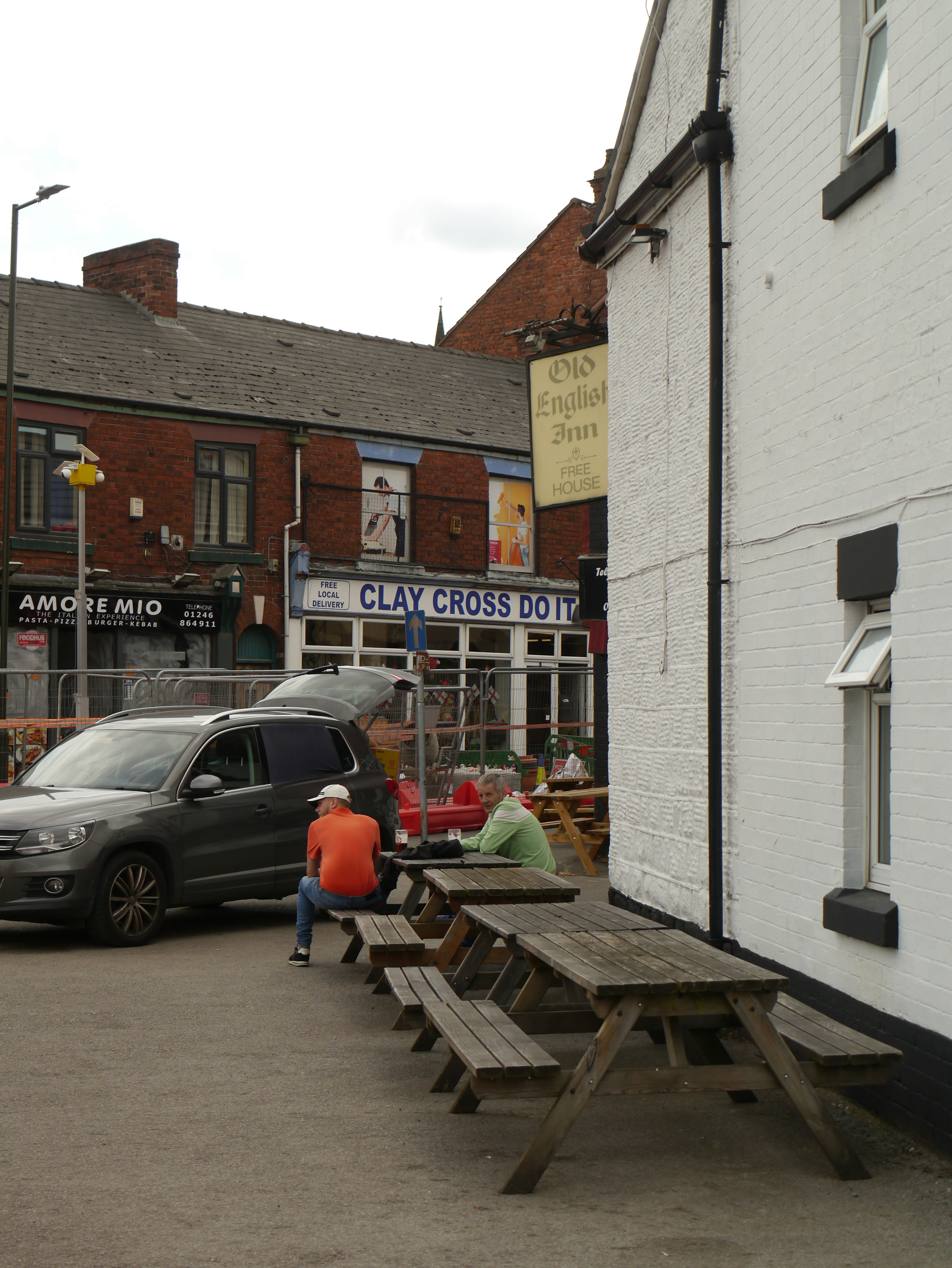 Street Corner Pause: Patrons at a Cheery Outdoor Eatery