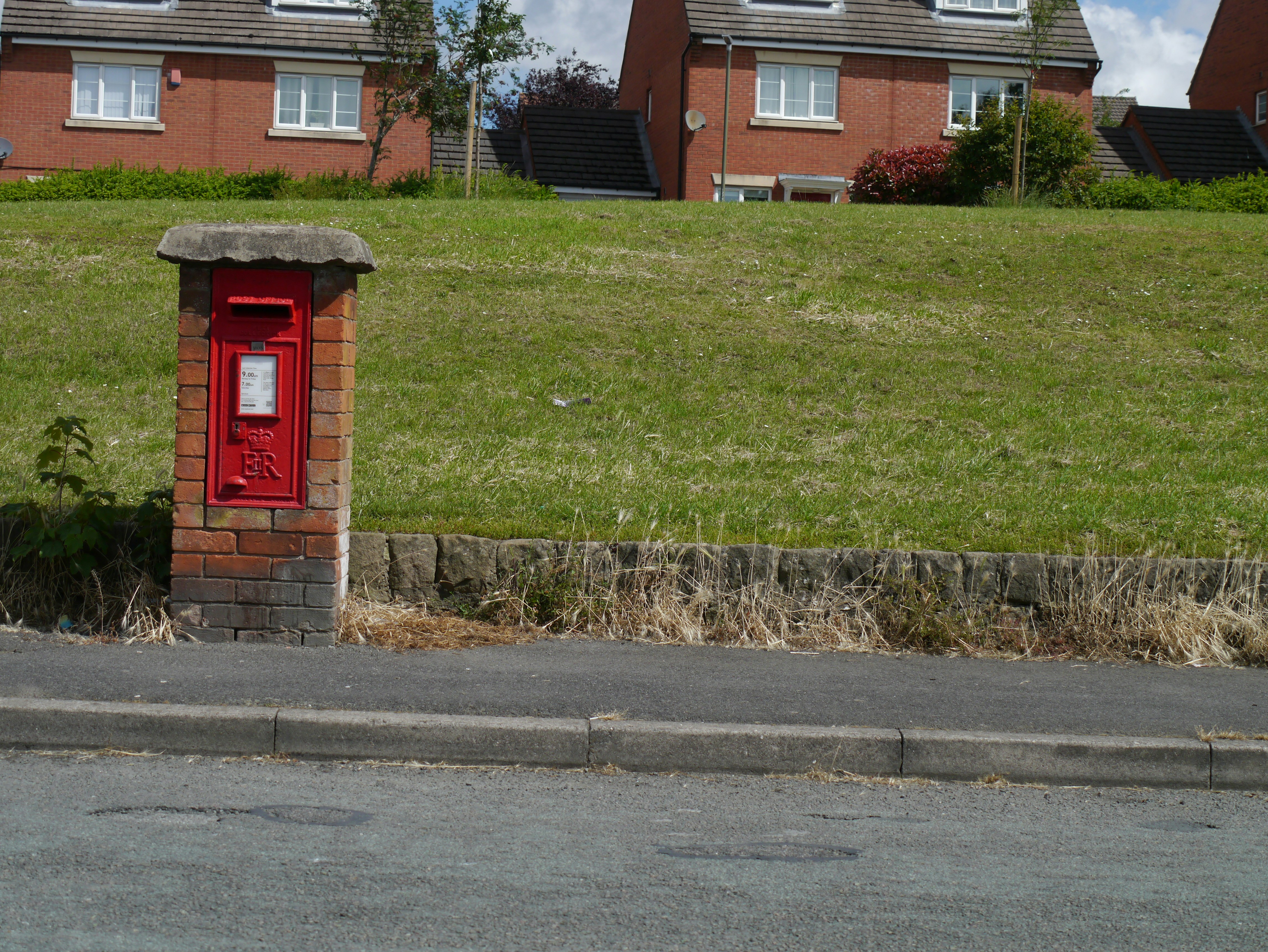 Red Mailbox Standing Watch Over a Quiet Suburban Street