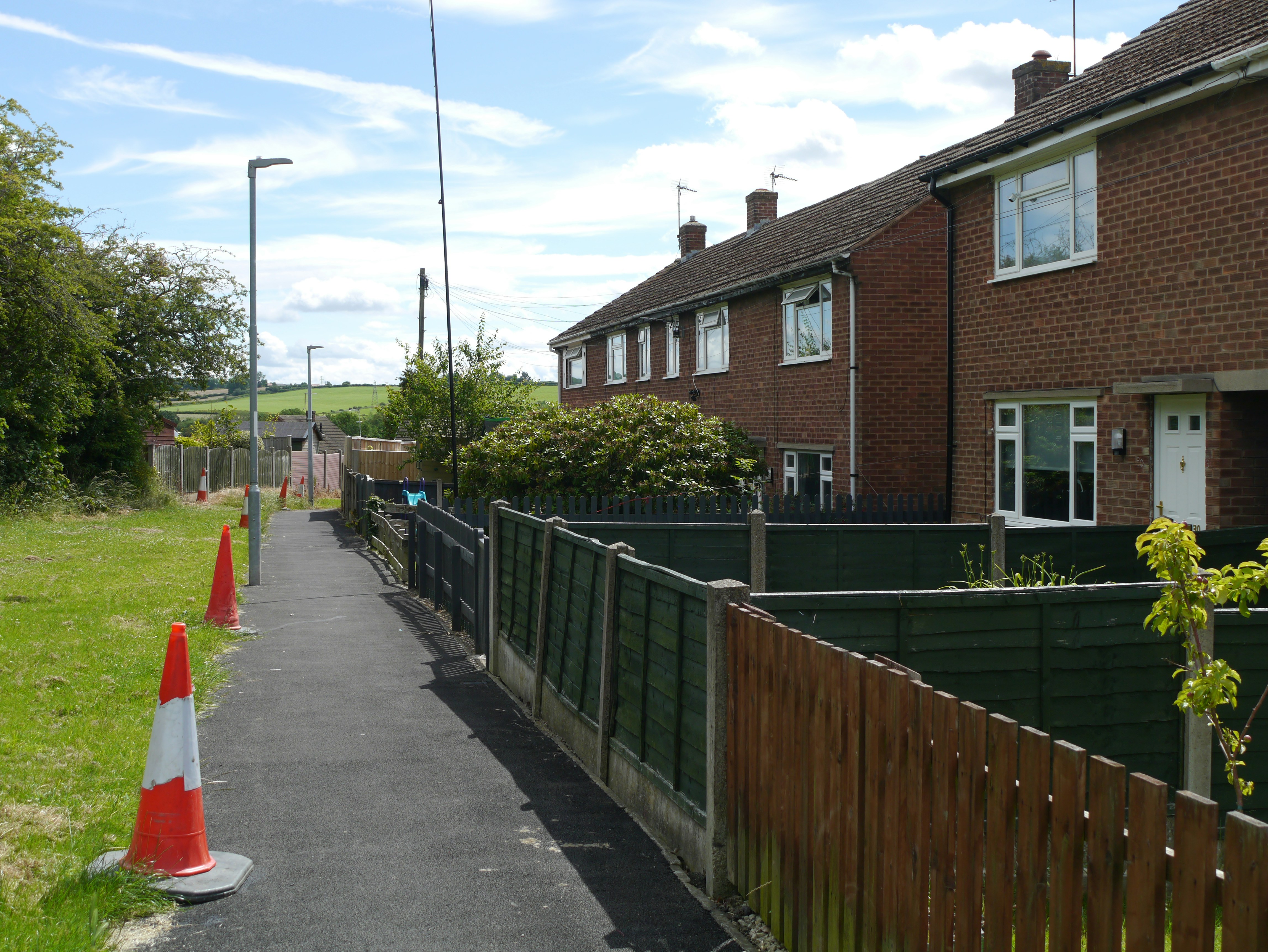 Constrained Sidewalk Beneath a Row of Brick Terraced Homes