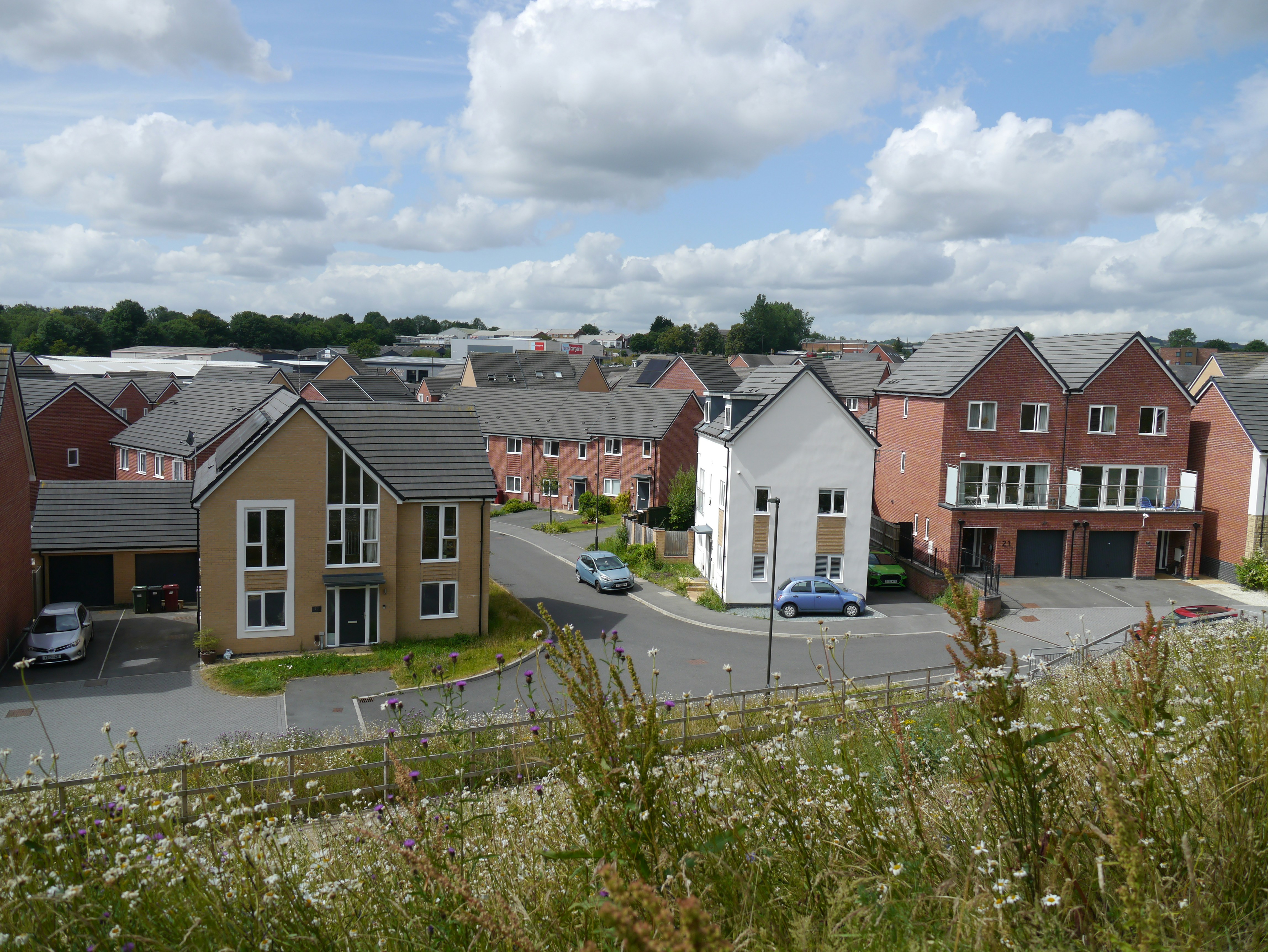 Row of neat suburban townhouses from a rooftop vantage