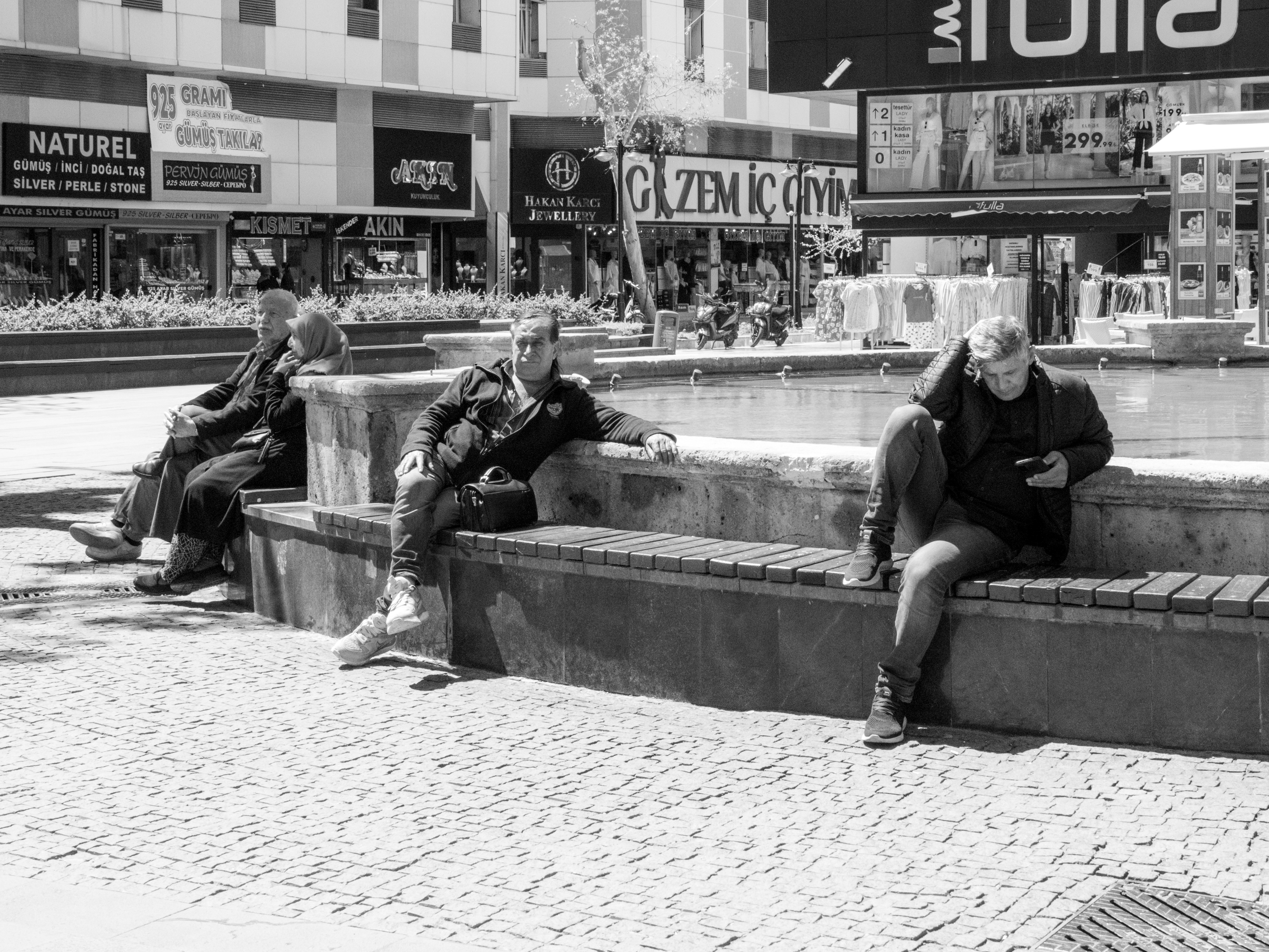 Three Quiet Faces in the Plaza Pool