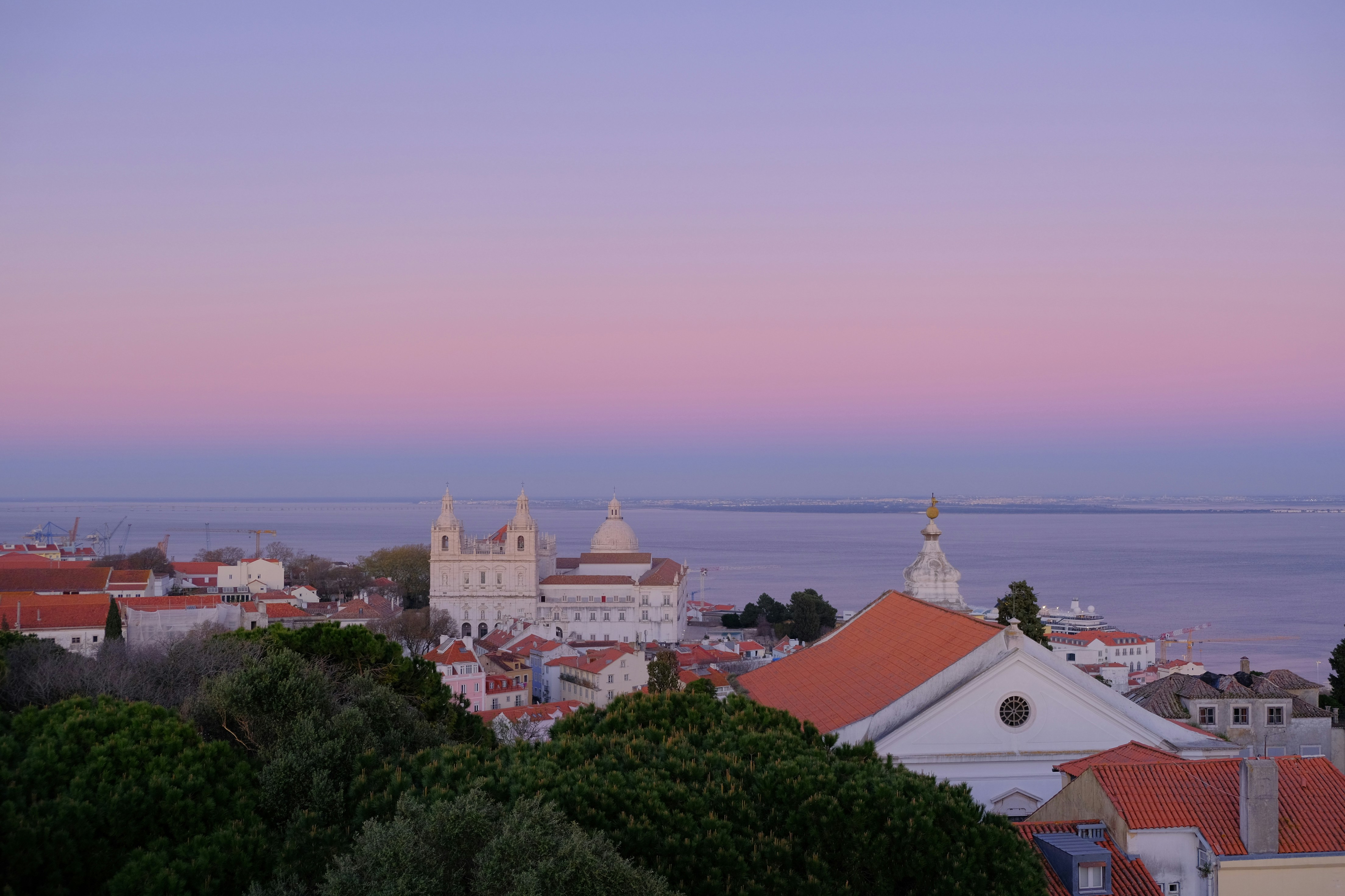 Sunset Over Cascais: Harbor Lights and Rooftop Mosaic