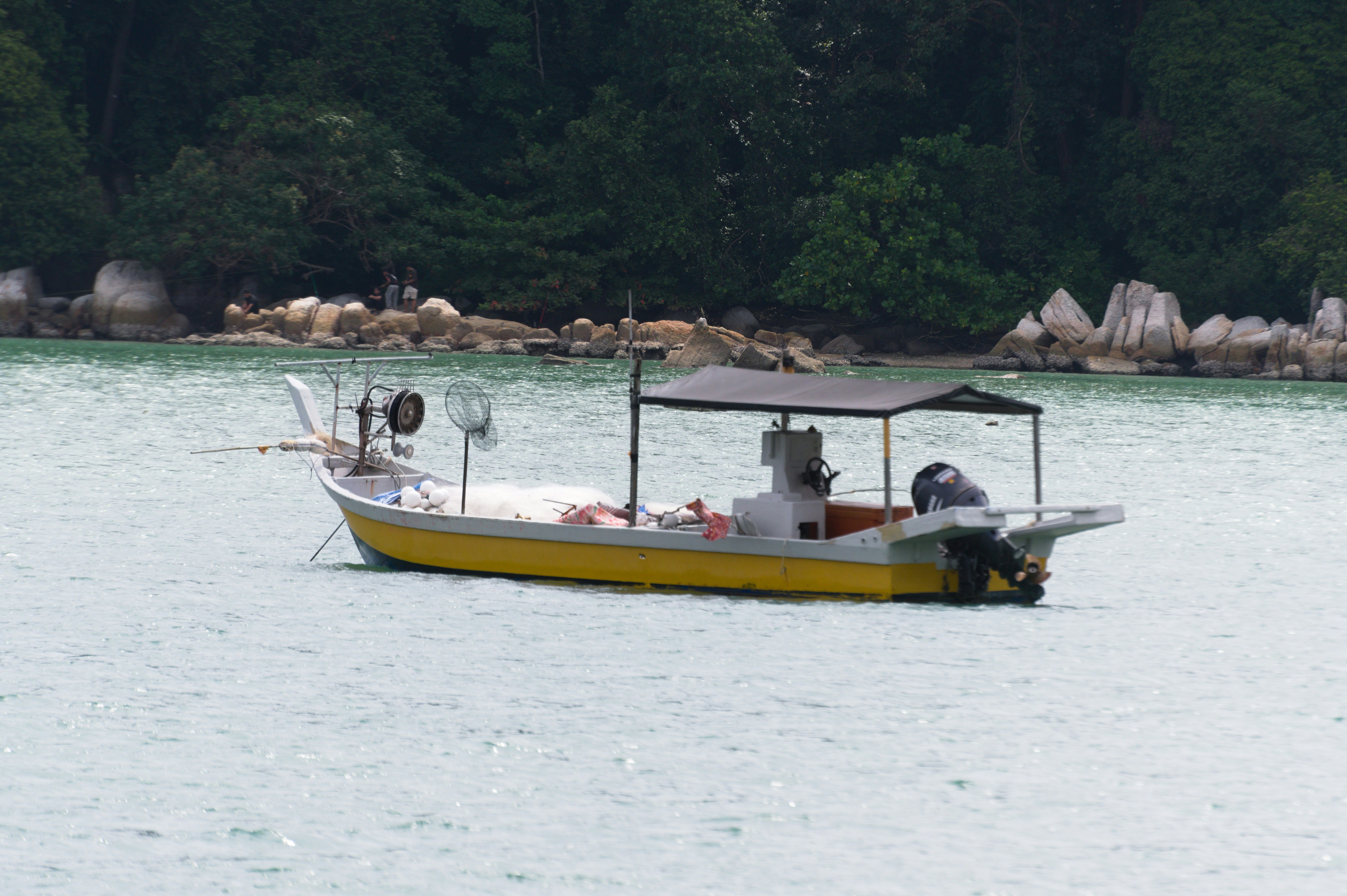 Yellow-tinted Workboat Rests in Coastal Calm