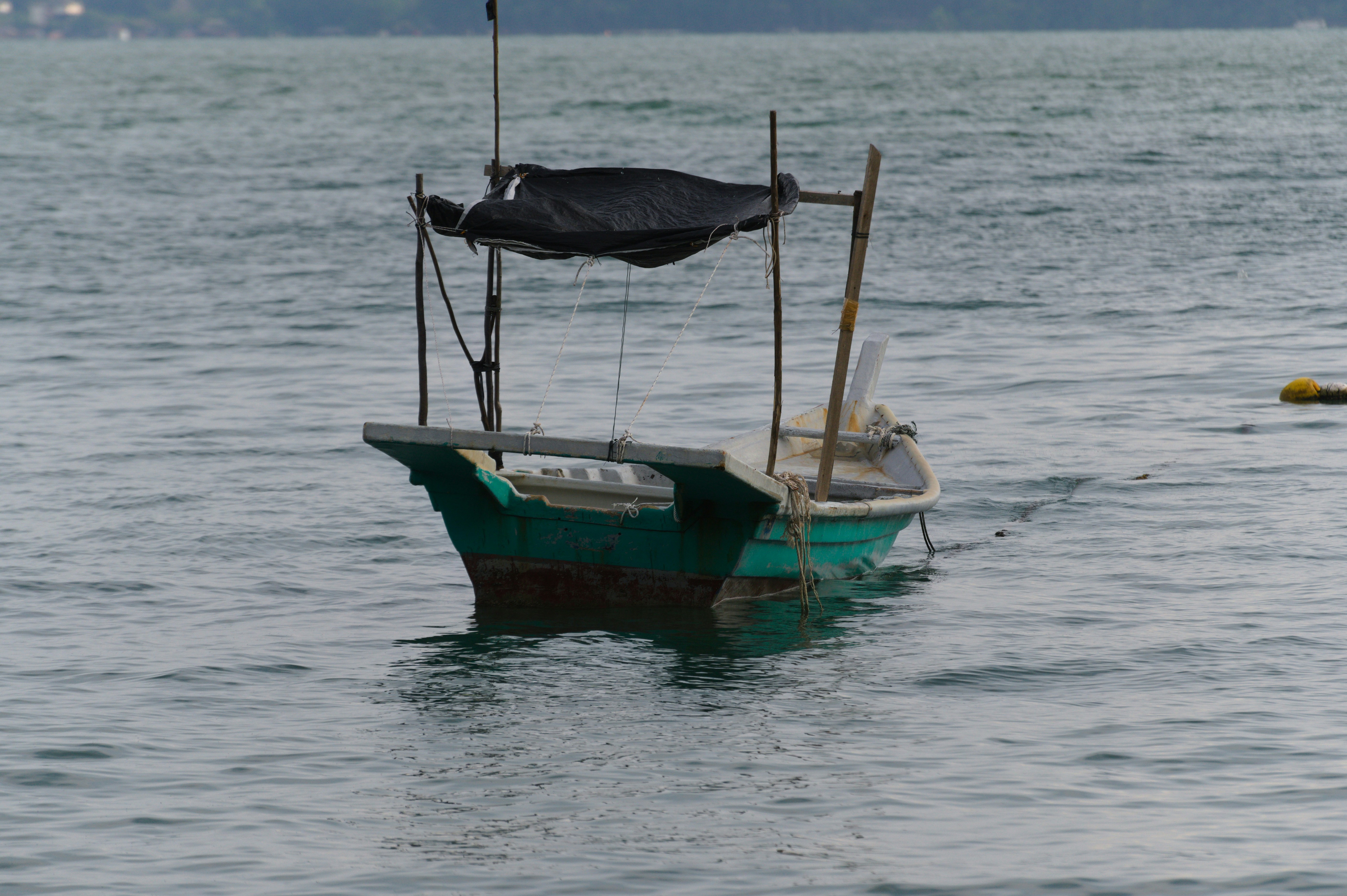 Lonely Green Boat on Quiet Sea