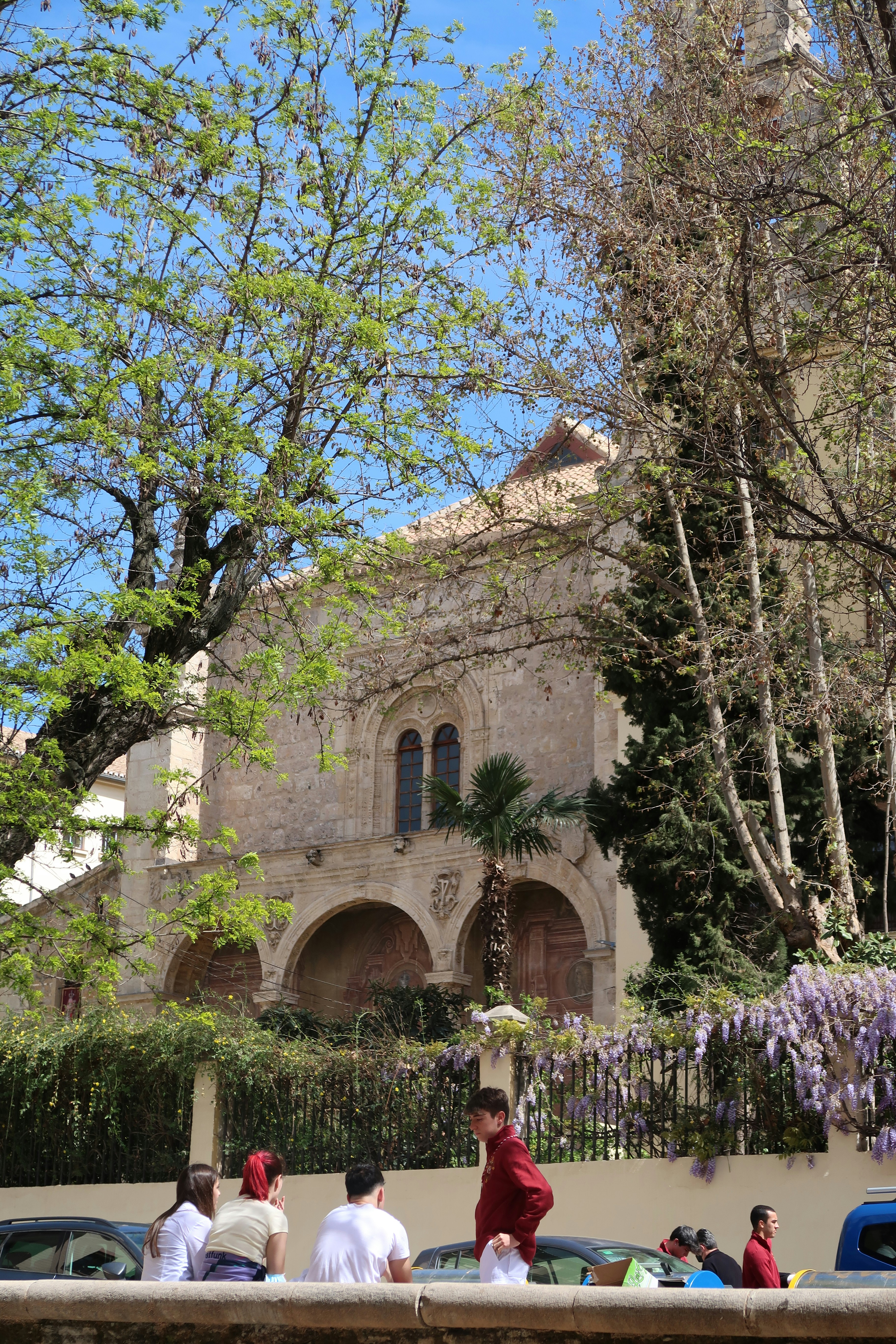 Sunlit Courtyard Choir: A stone church and a lively street scene