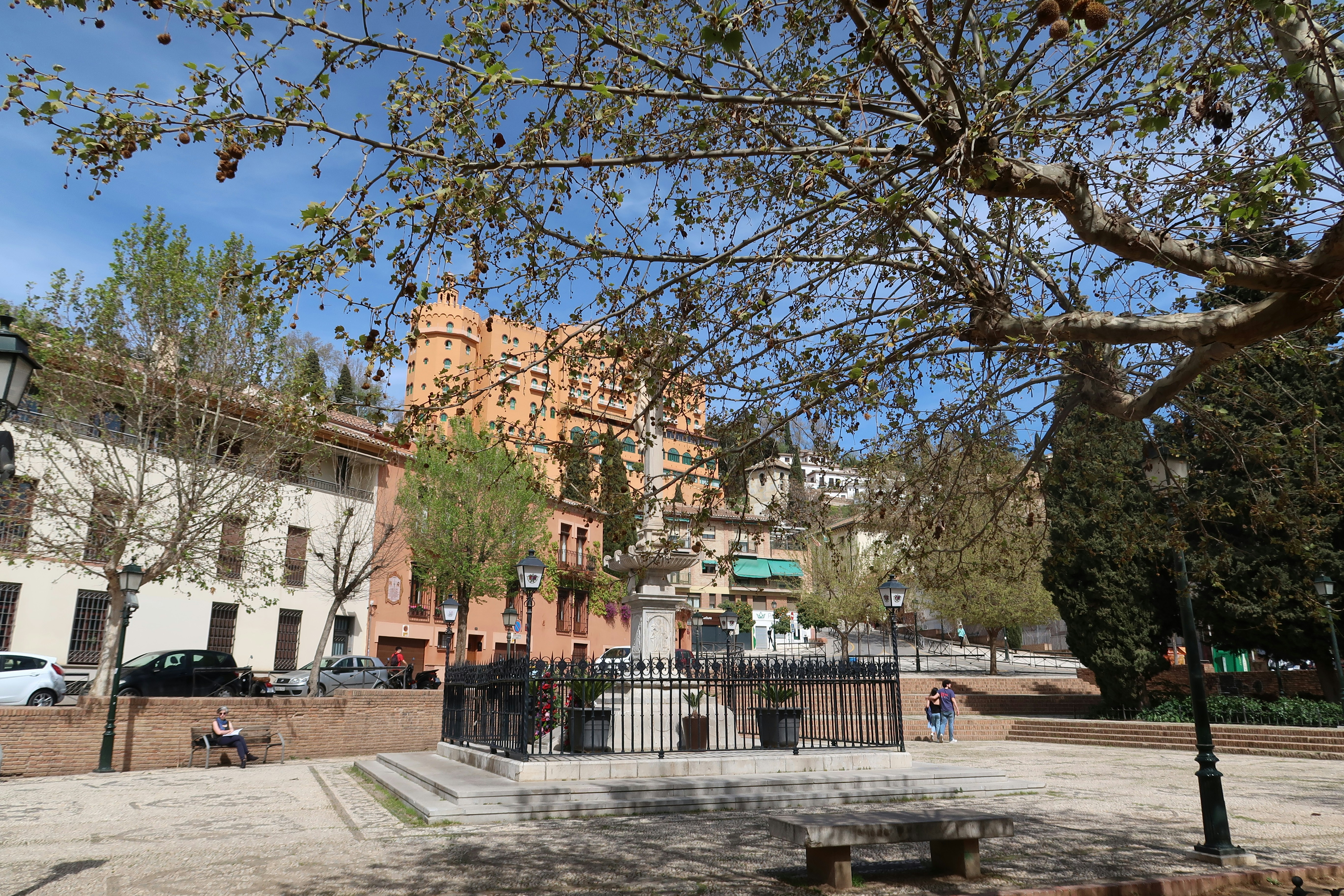 Urban Plaza with Historic Fountain Under Blooming Trees