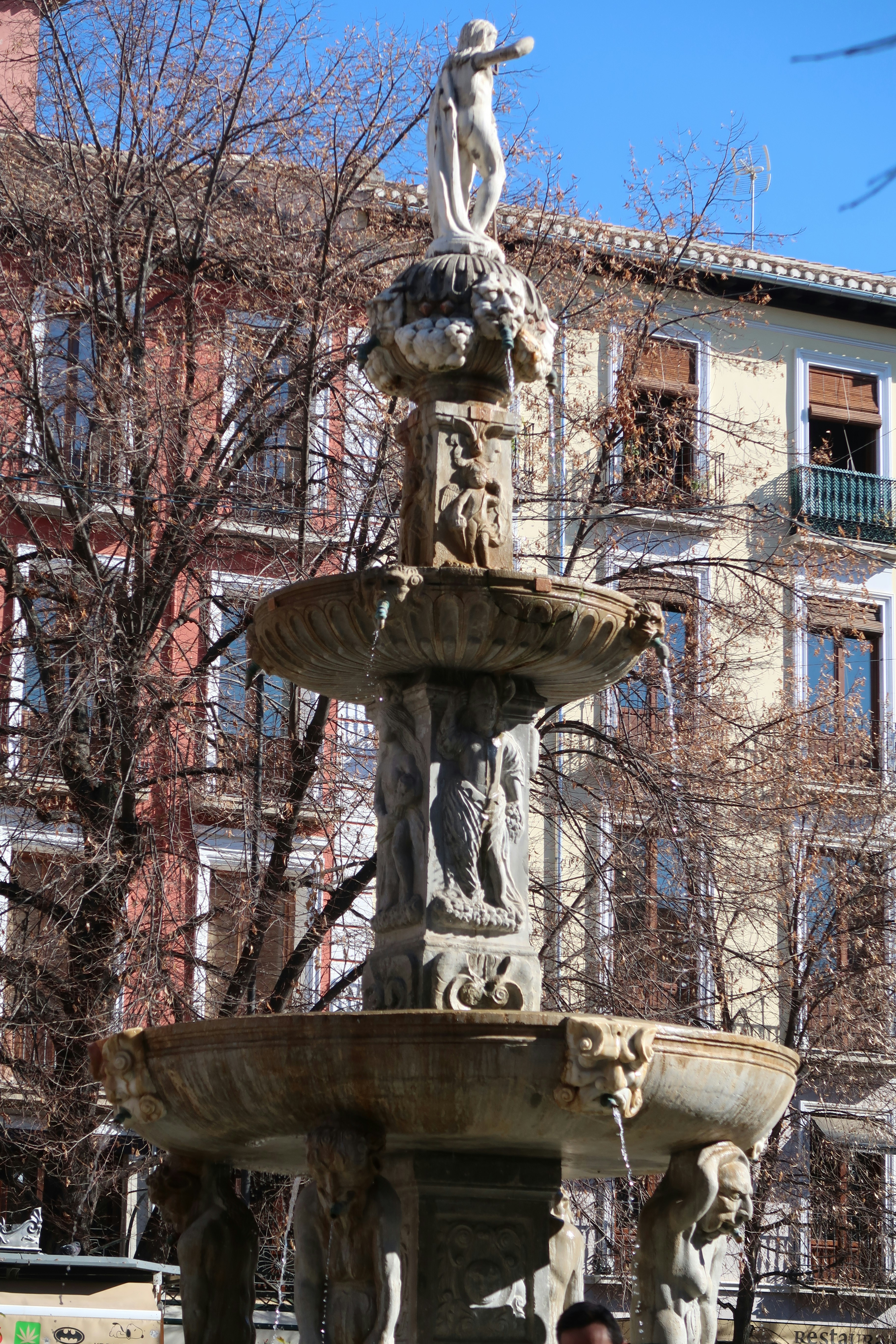 Stone Fountain Witness in a Sunlit City Block