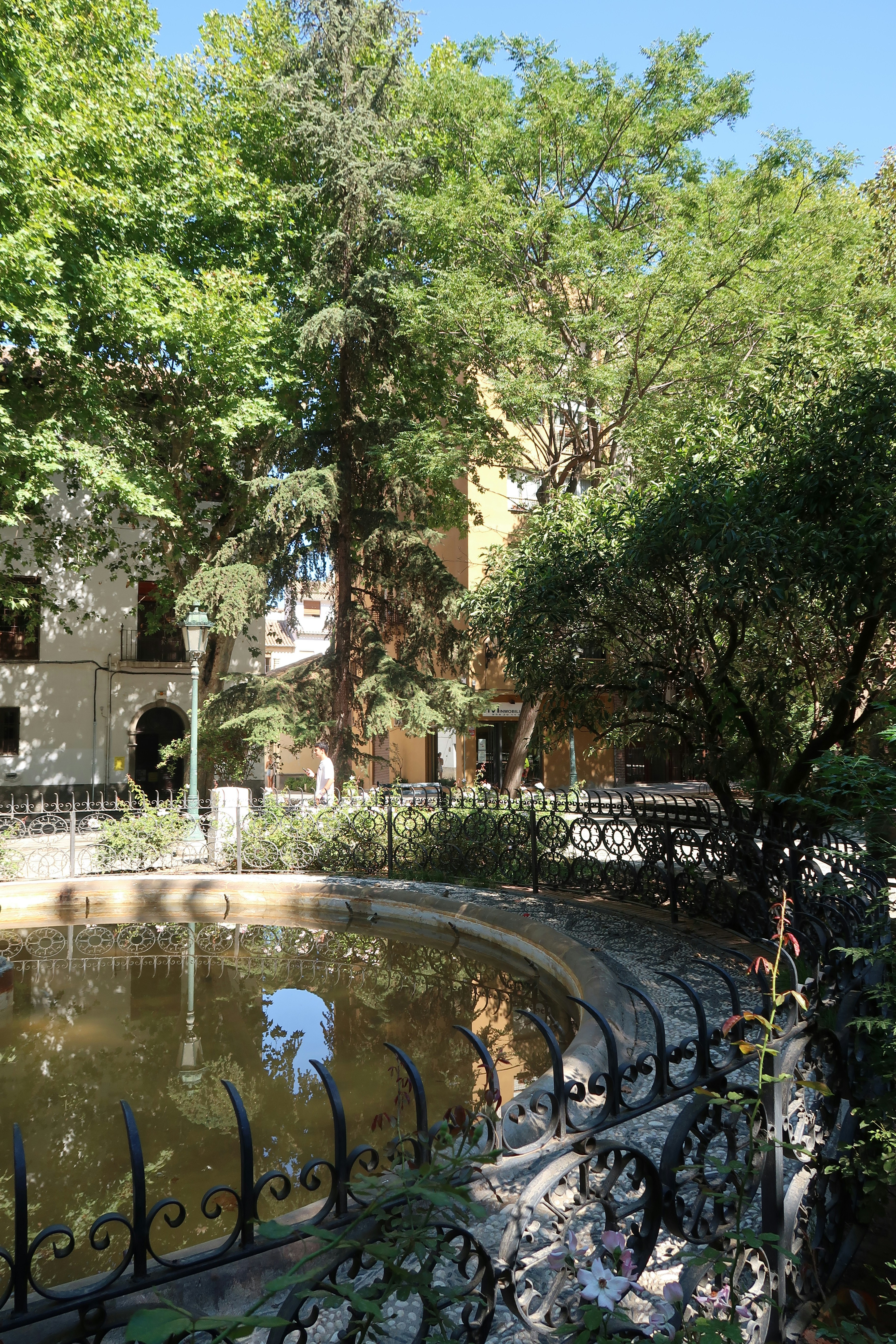 Quiet Tile Fountain Framed by Shade and Architecture