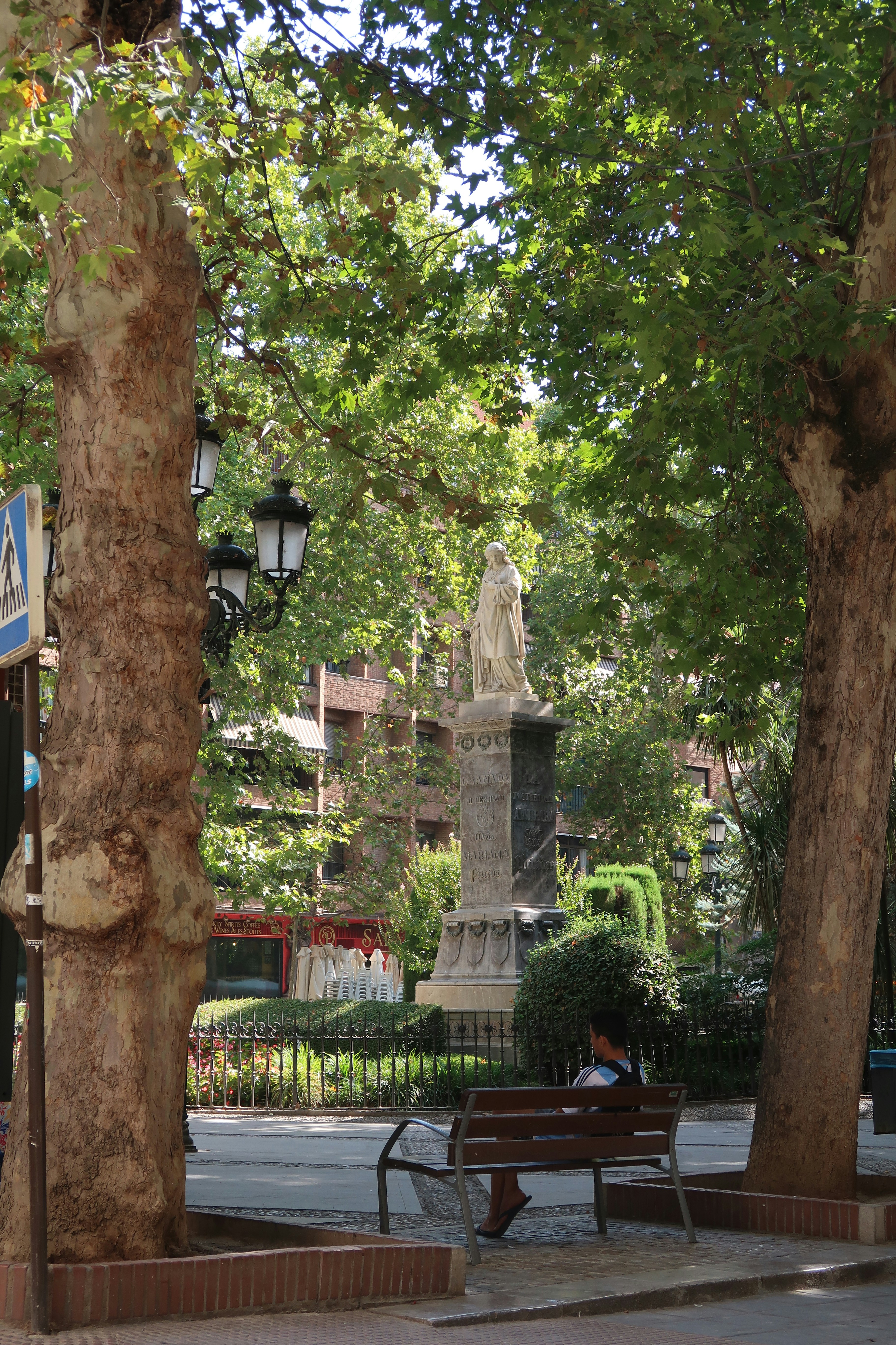 Statue at the Park: A Quiet Moment by the Benched Figure