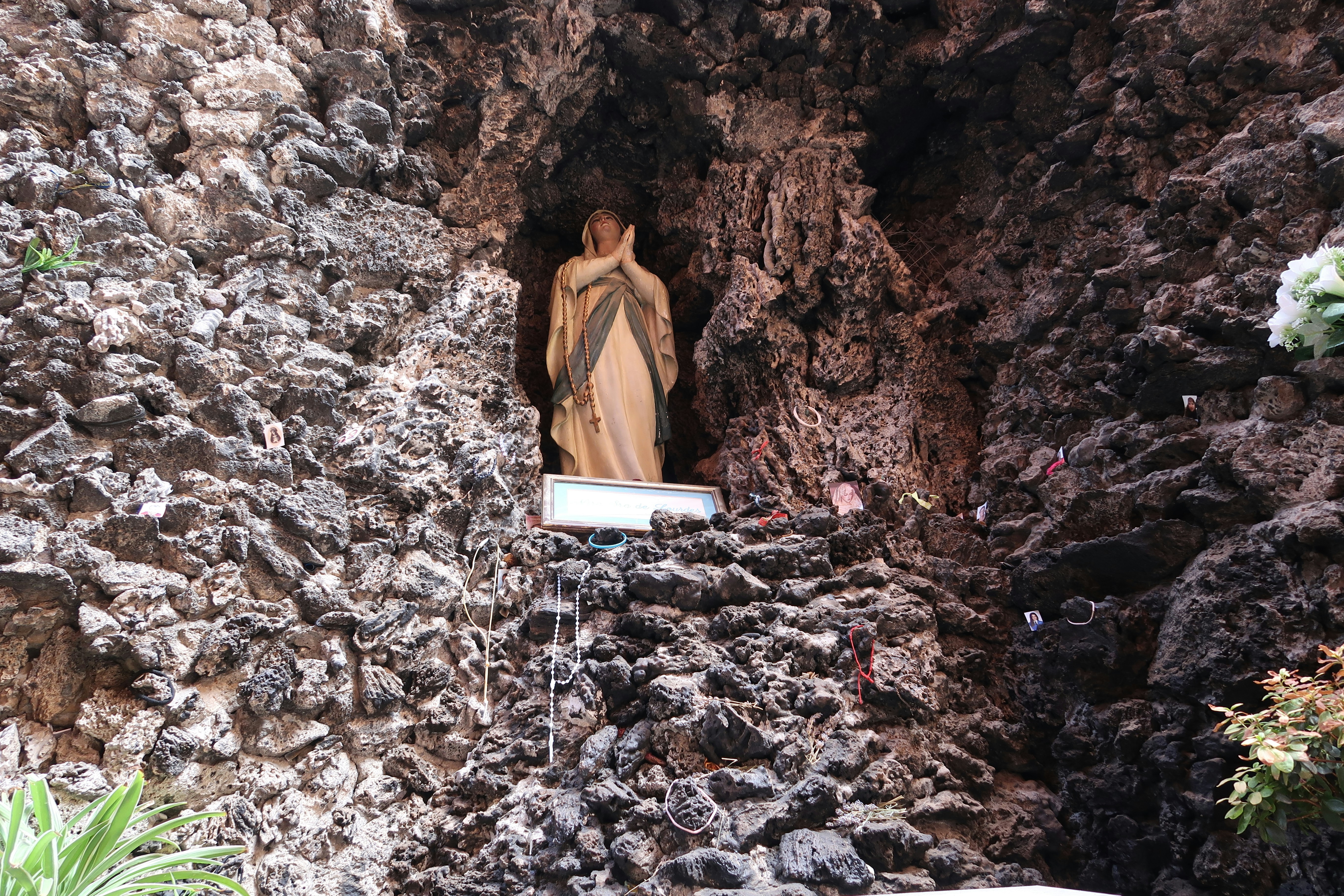 Statue in a rocky grotto: a quiet shrine among rough stone