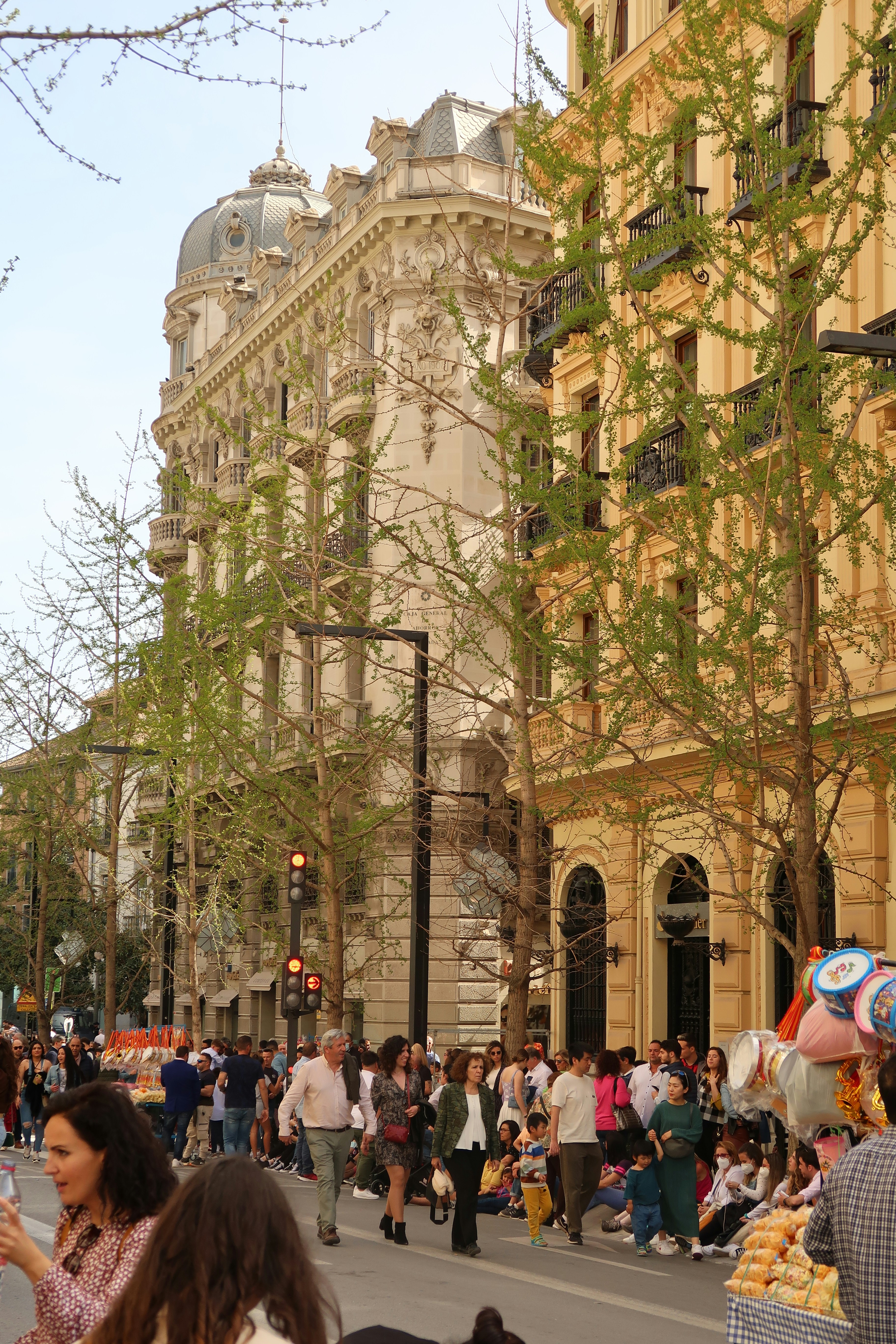Sunlit Façade and Crowded Street in a European Avenue