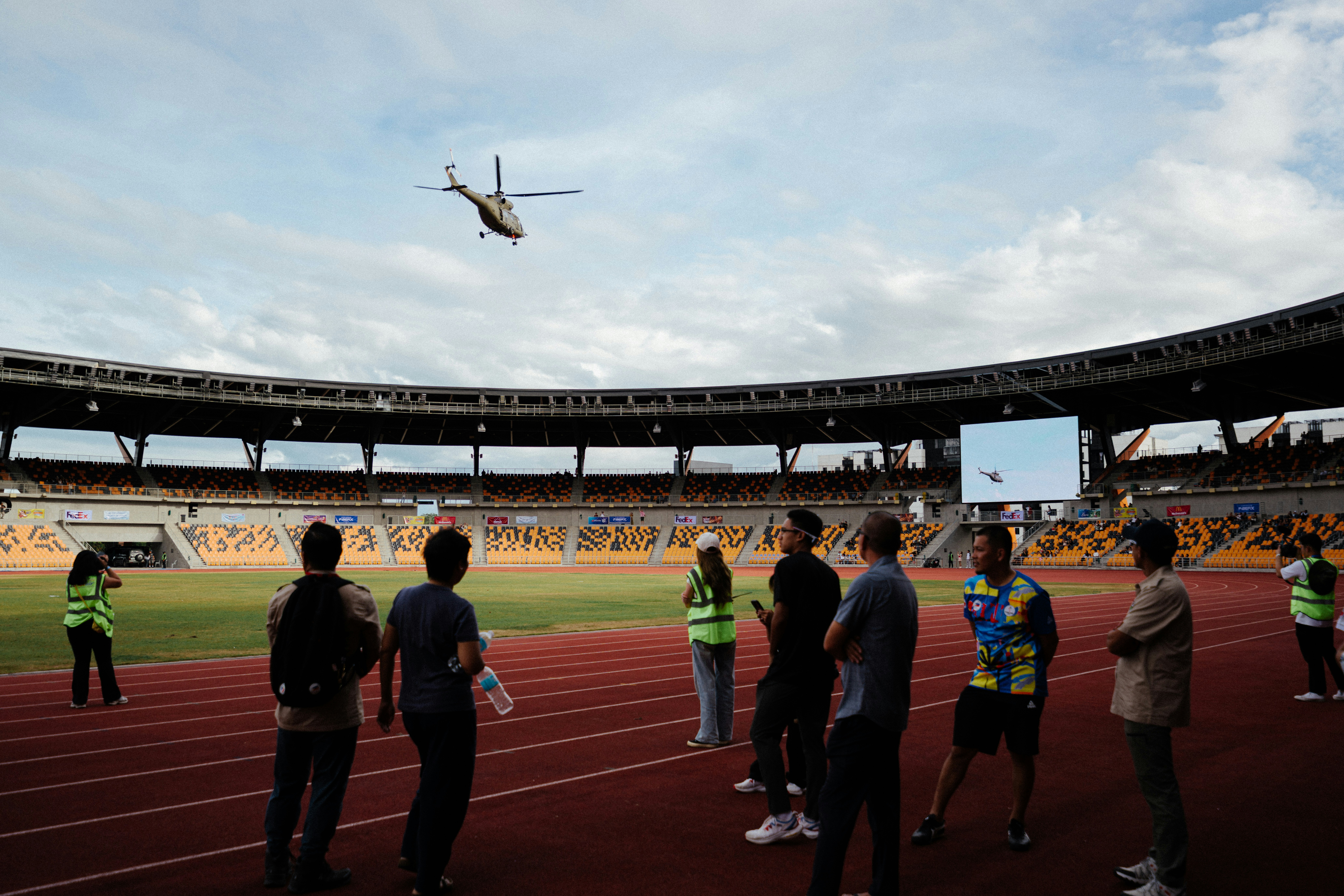 Helicopter Lift-Off Over a Stadium Crowd