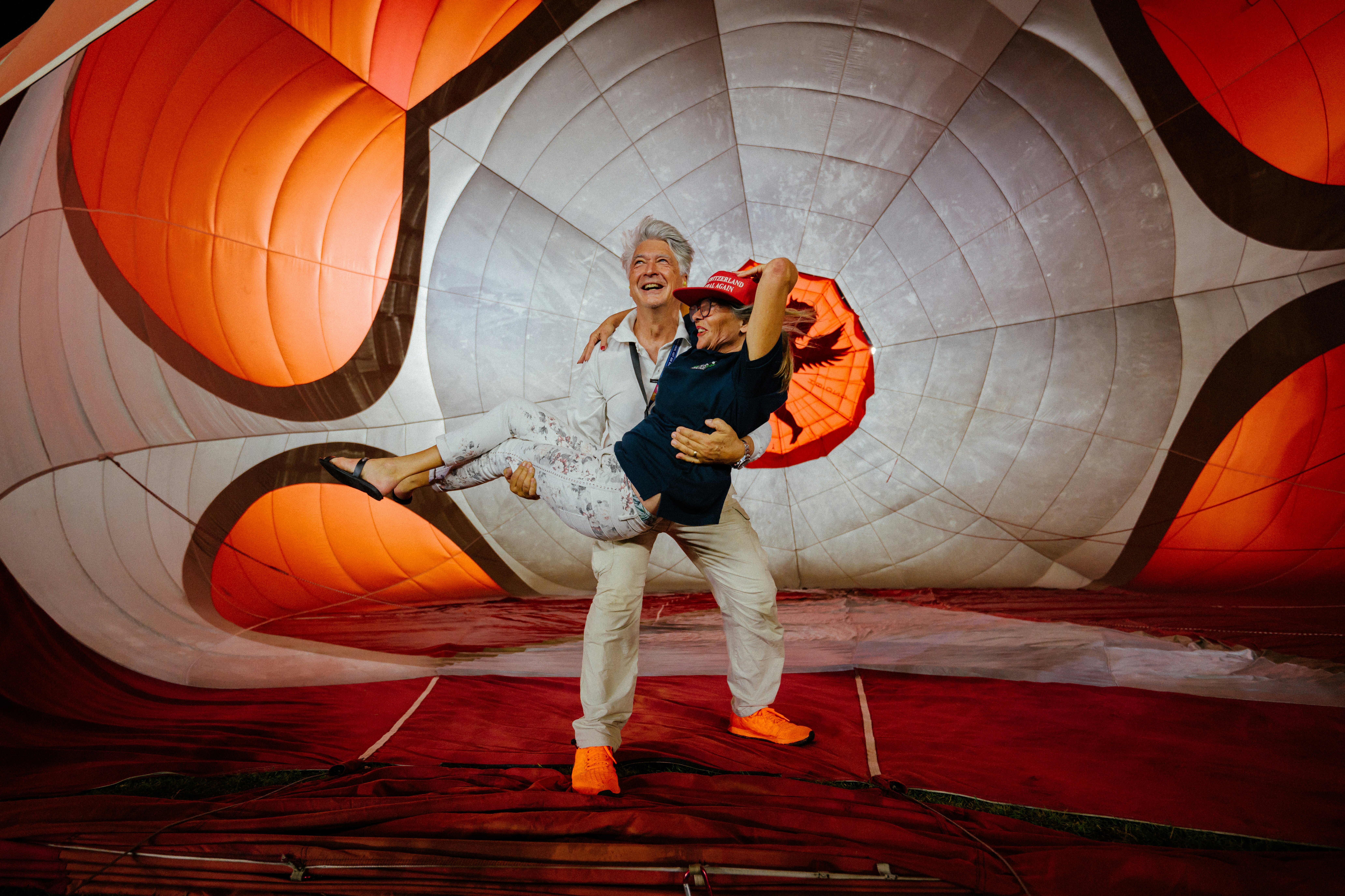 Inverted Dance: A Couple's Joy Inside a Ballooning Red-Ambience