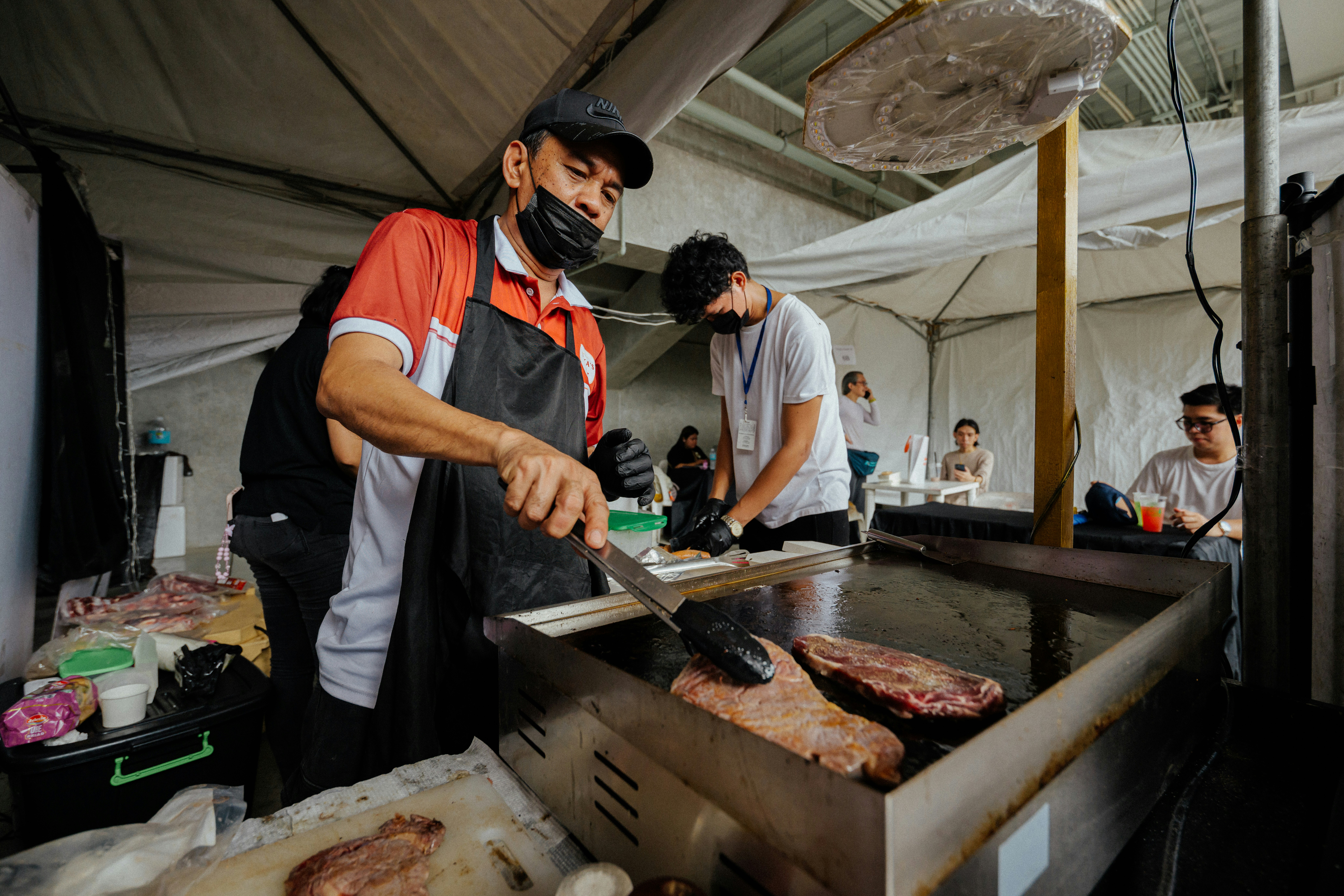 Grill Master in Action: Sizzling Moments at a Food Stall