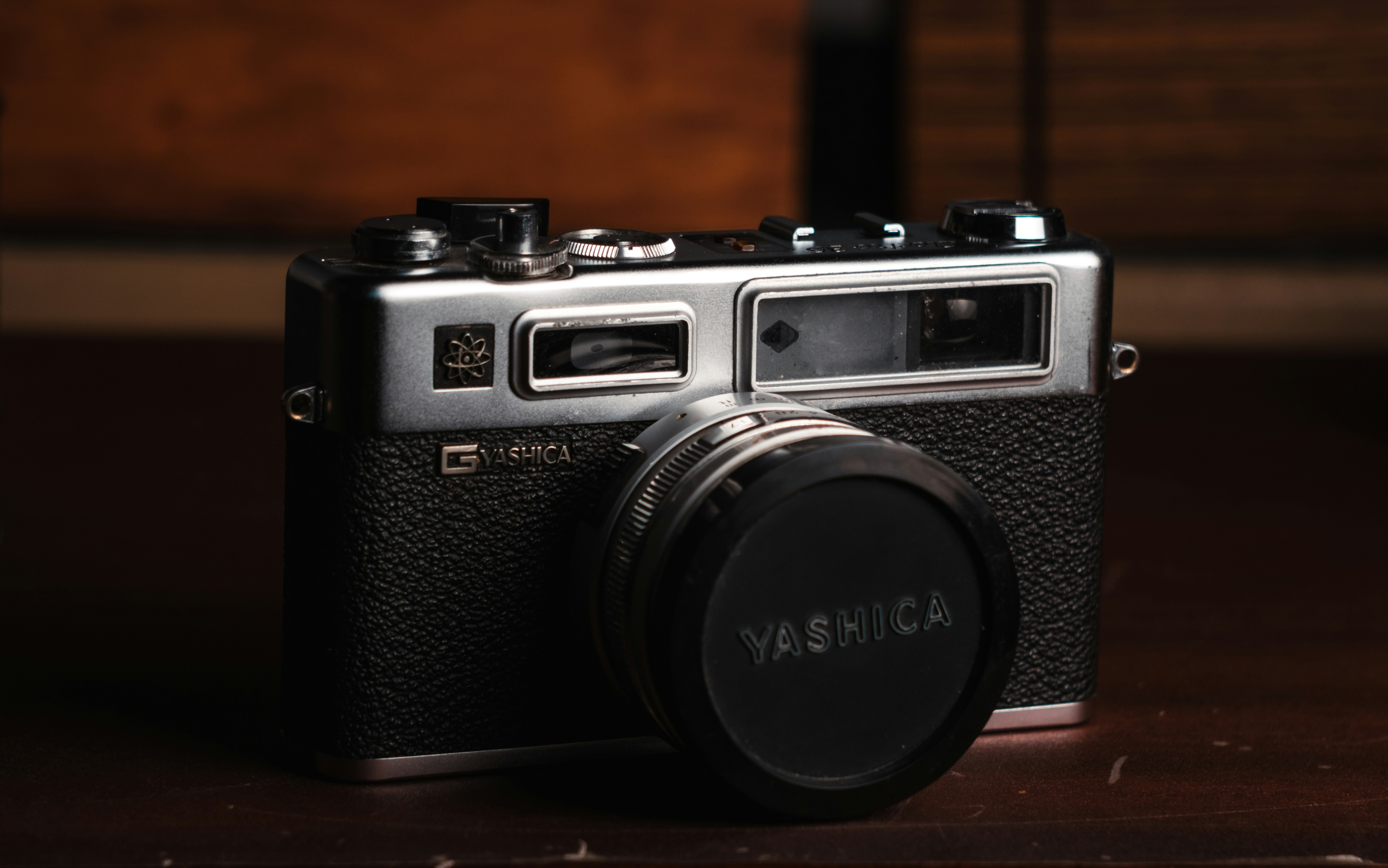 Metallic vintage: a Yashica rangefinder resting on a wooden surface