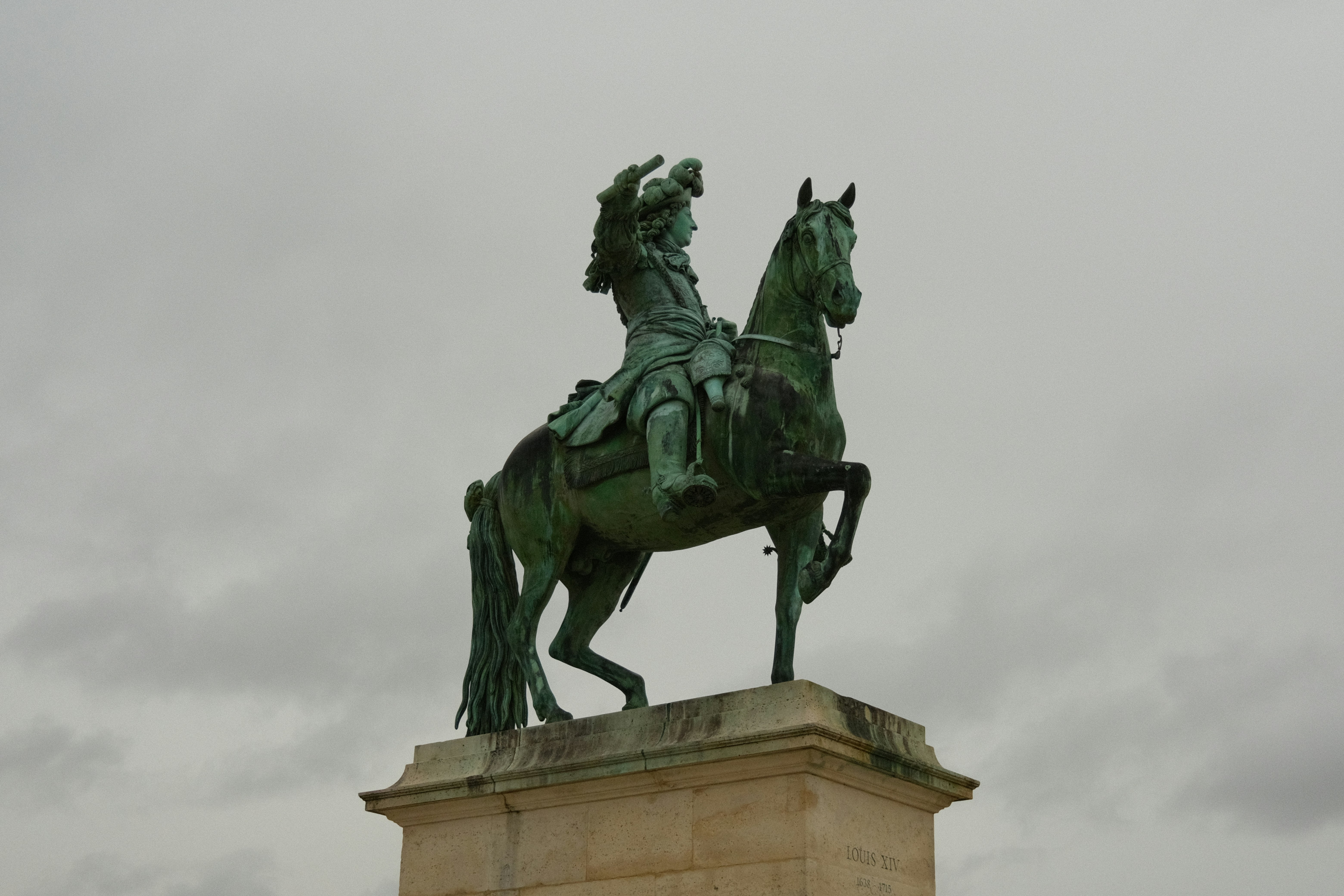Bronze Rider on a Stone Pedestal under Pale Skies